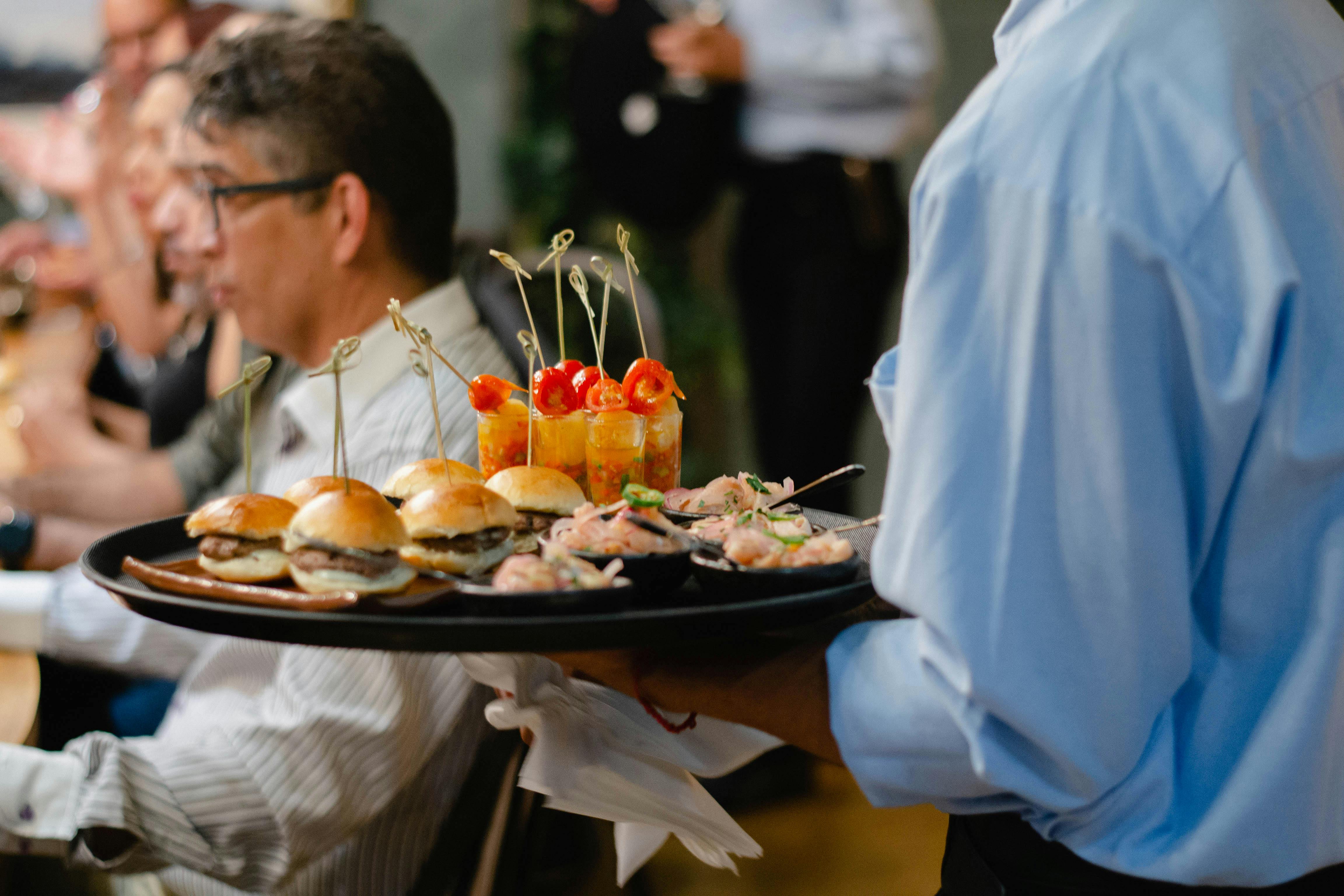 Waiter Carrying Tray with Snacks · Free Stock Photo