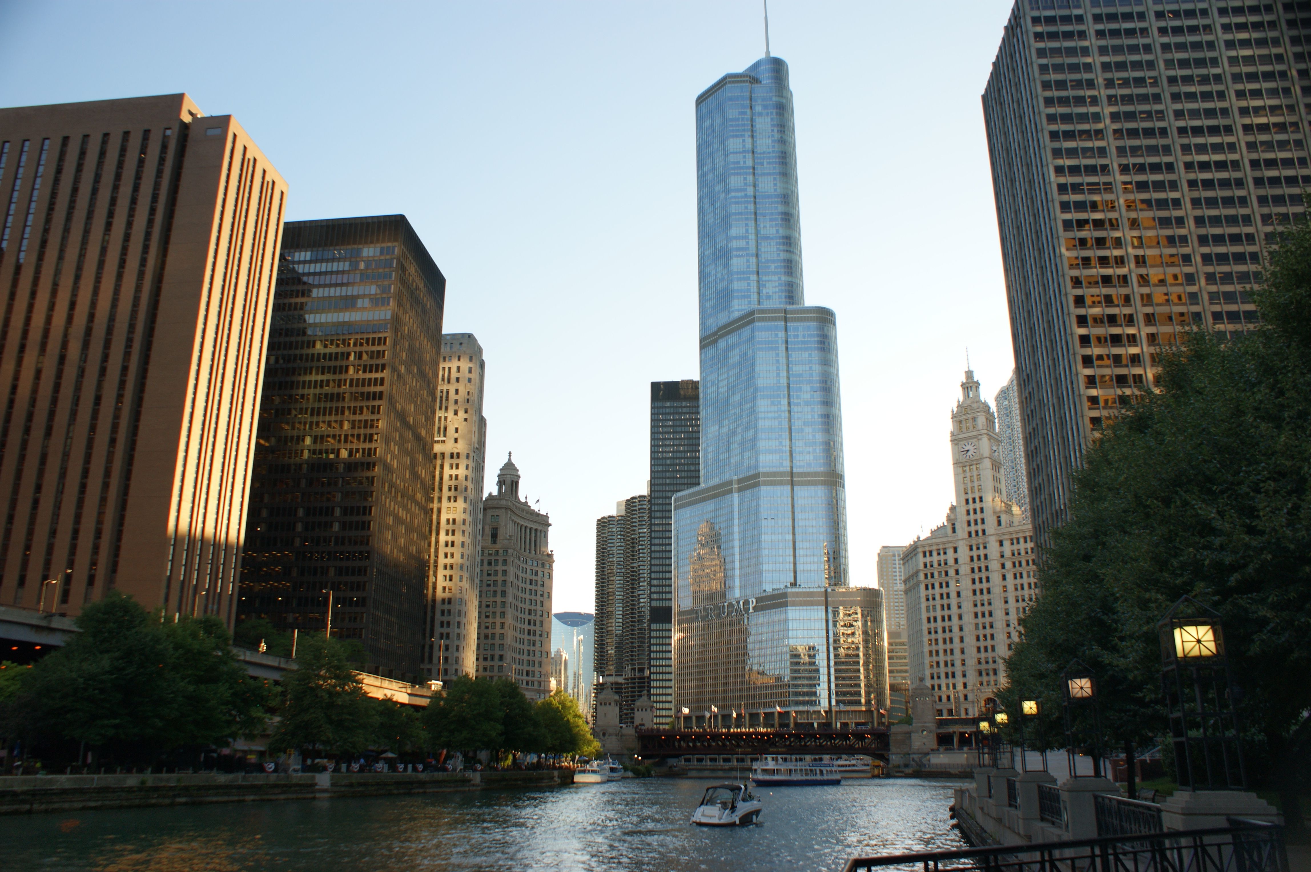 Reflective Glass Skyscraper on Canal Shore · Free Stock Photo