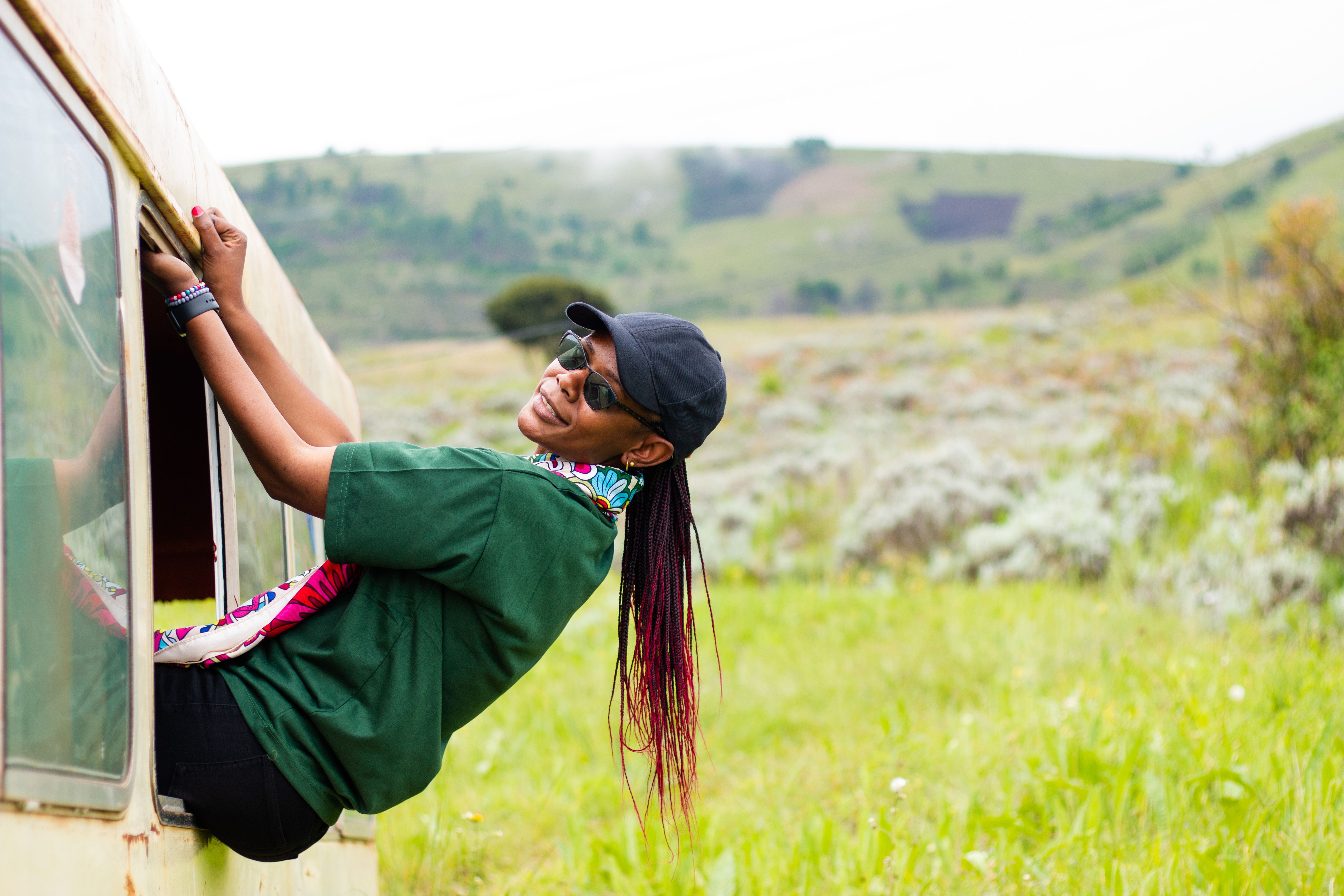 Photo of a Young Woman Leaning Out of a Caravan Window in a Meadow ...