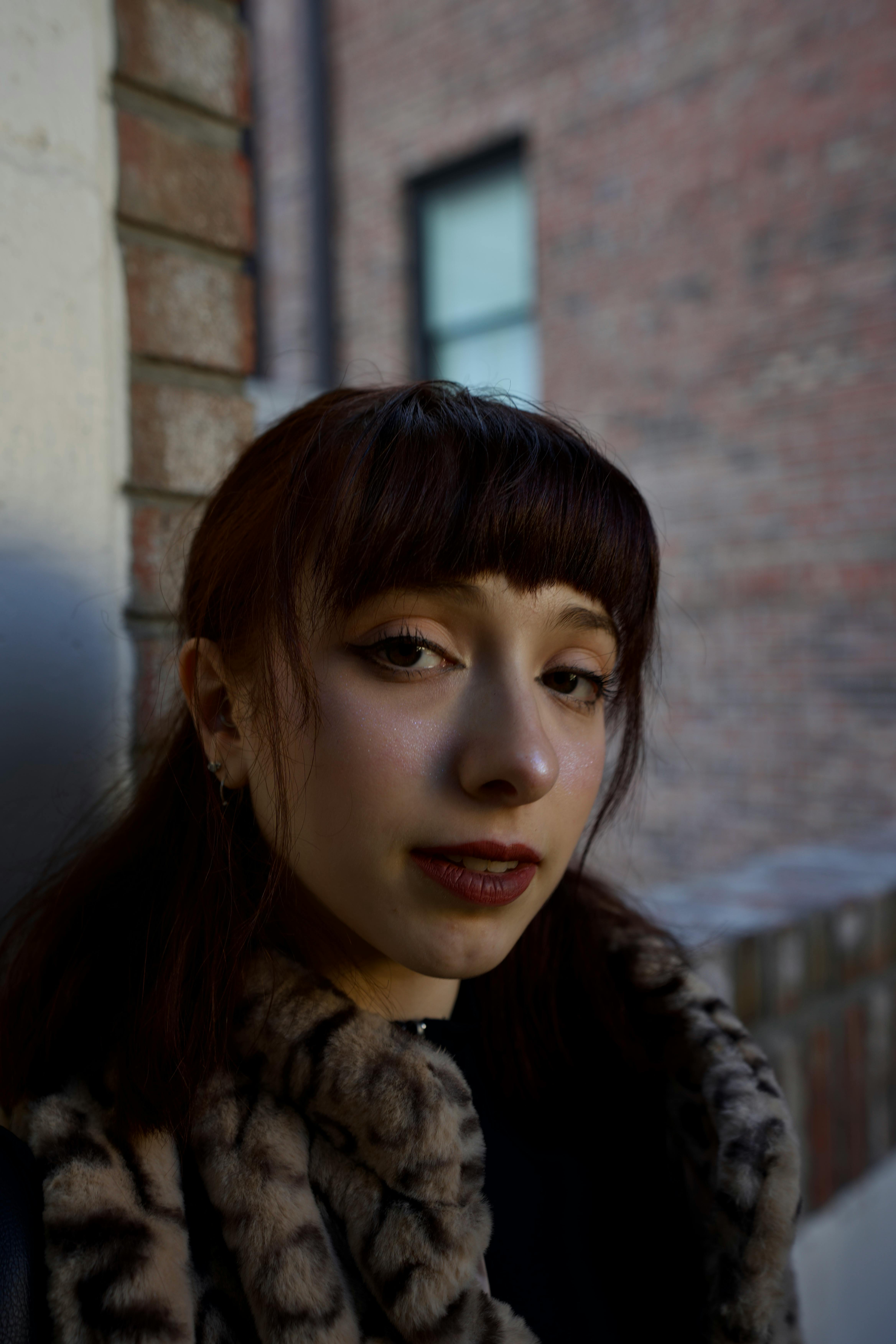 Face of Woman near Building Walls · Free Stock Photo