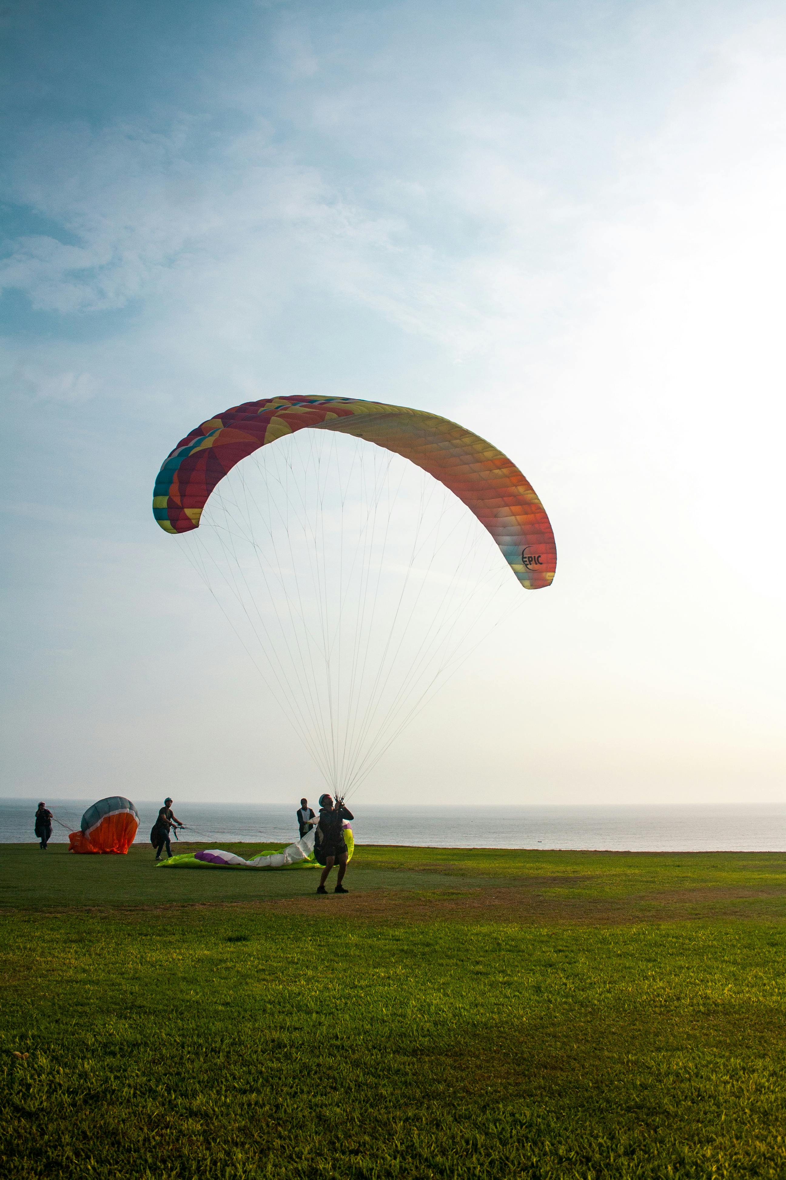 Sunlight over People Parachuting in Town · Free Stock Photo