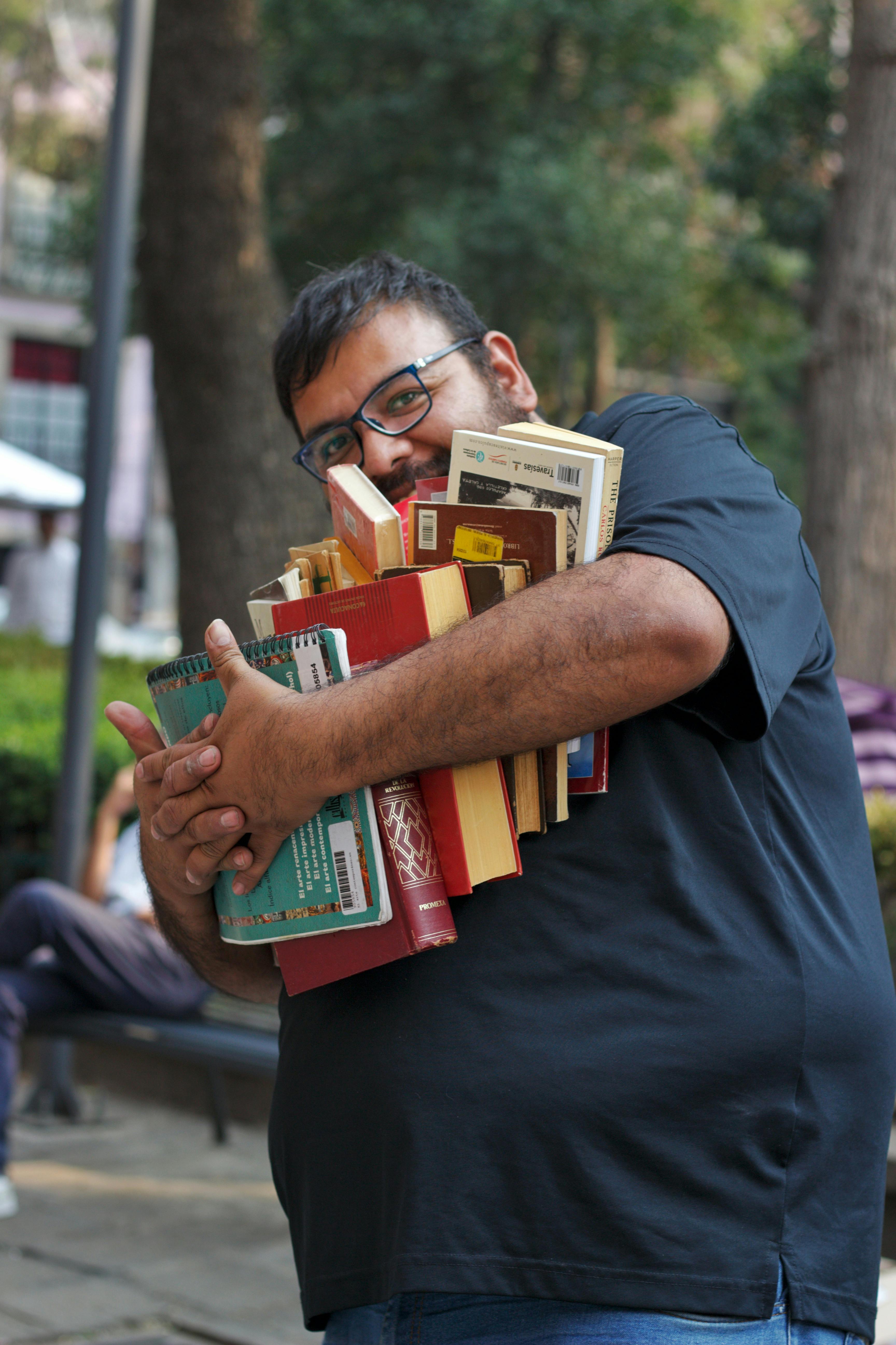 Man Posing with Books · Free Stock Photo