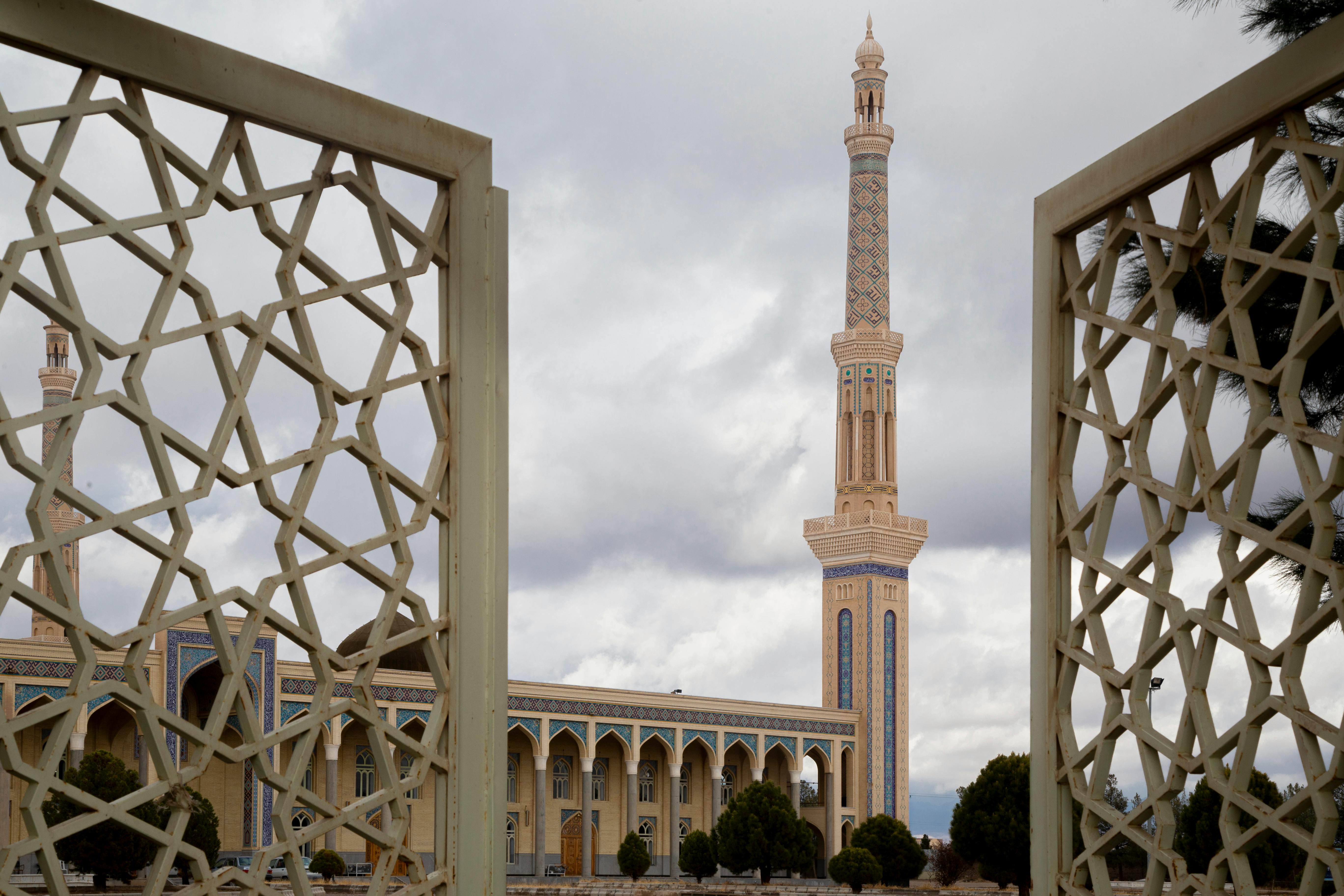Mosque and a Minaret behind an Open Gate · Free Stock Photo