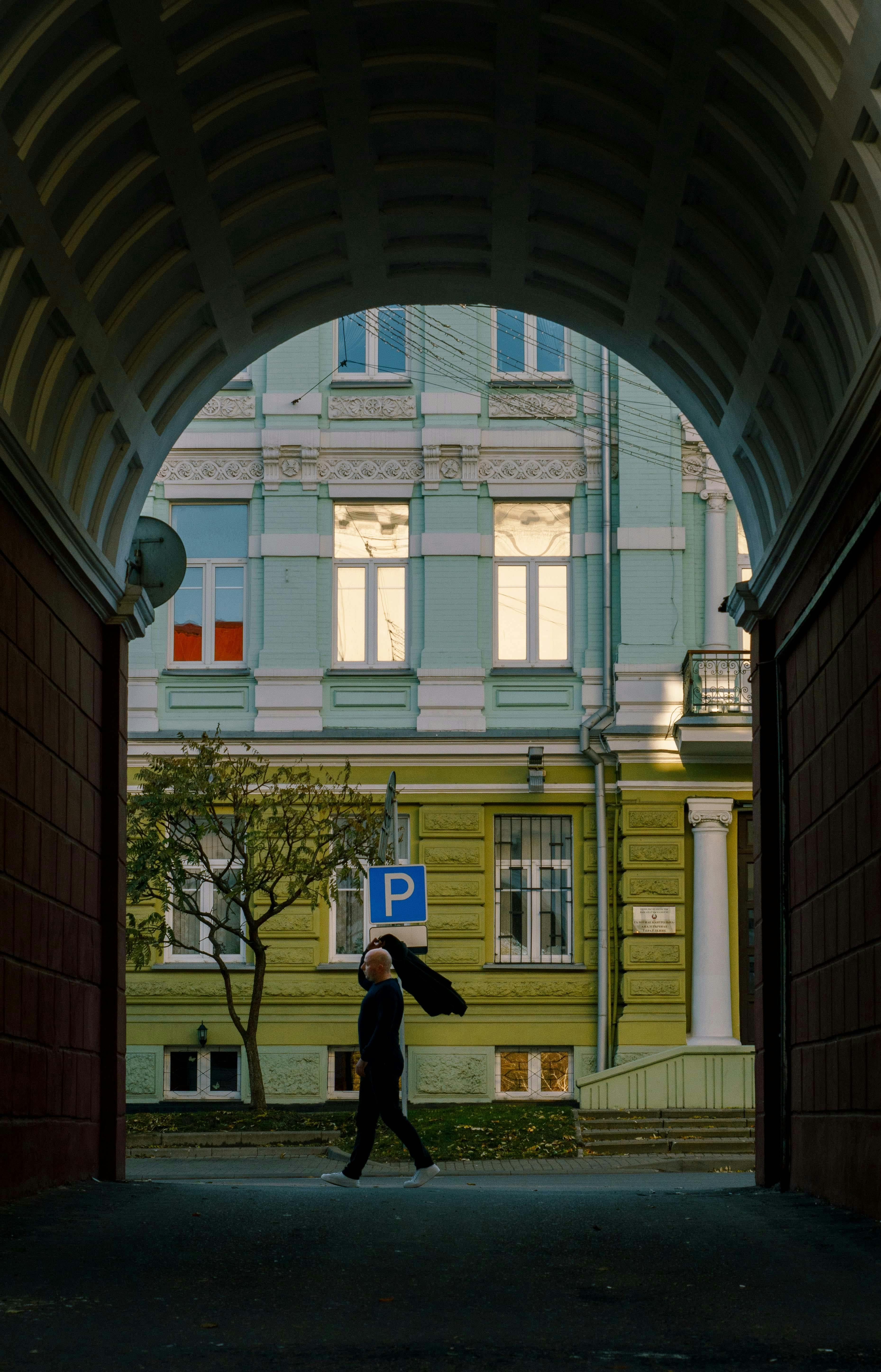 Facade of a City Building Seen through an Arched Passage · Free Stock Photo
