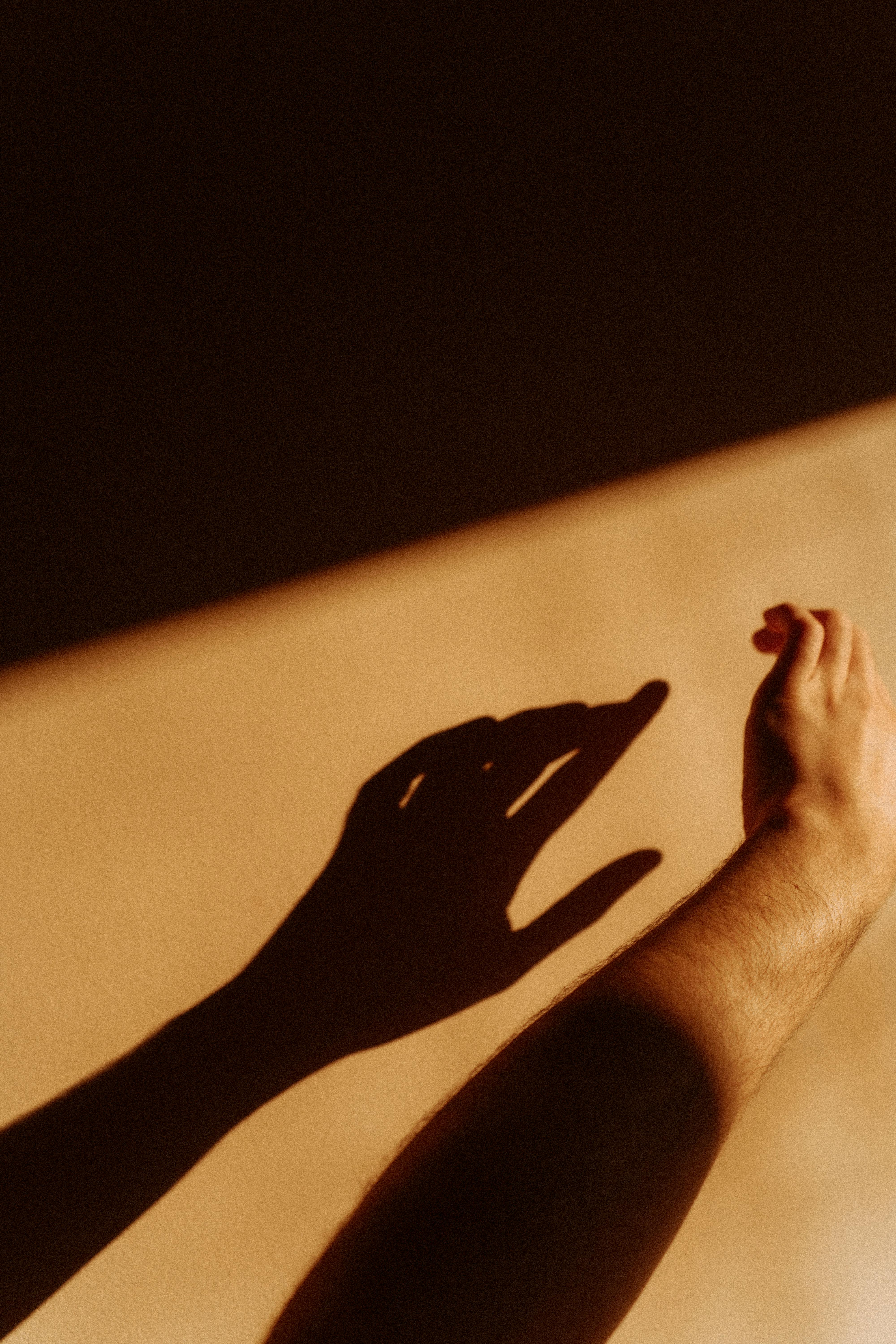 Close-up of Man Arm Shadow on Wall · Free Stock Photo
