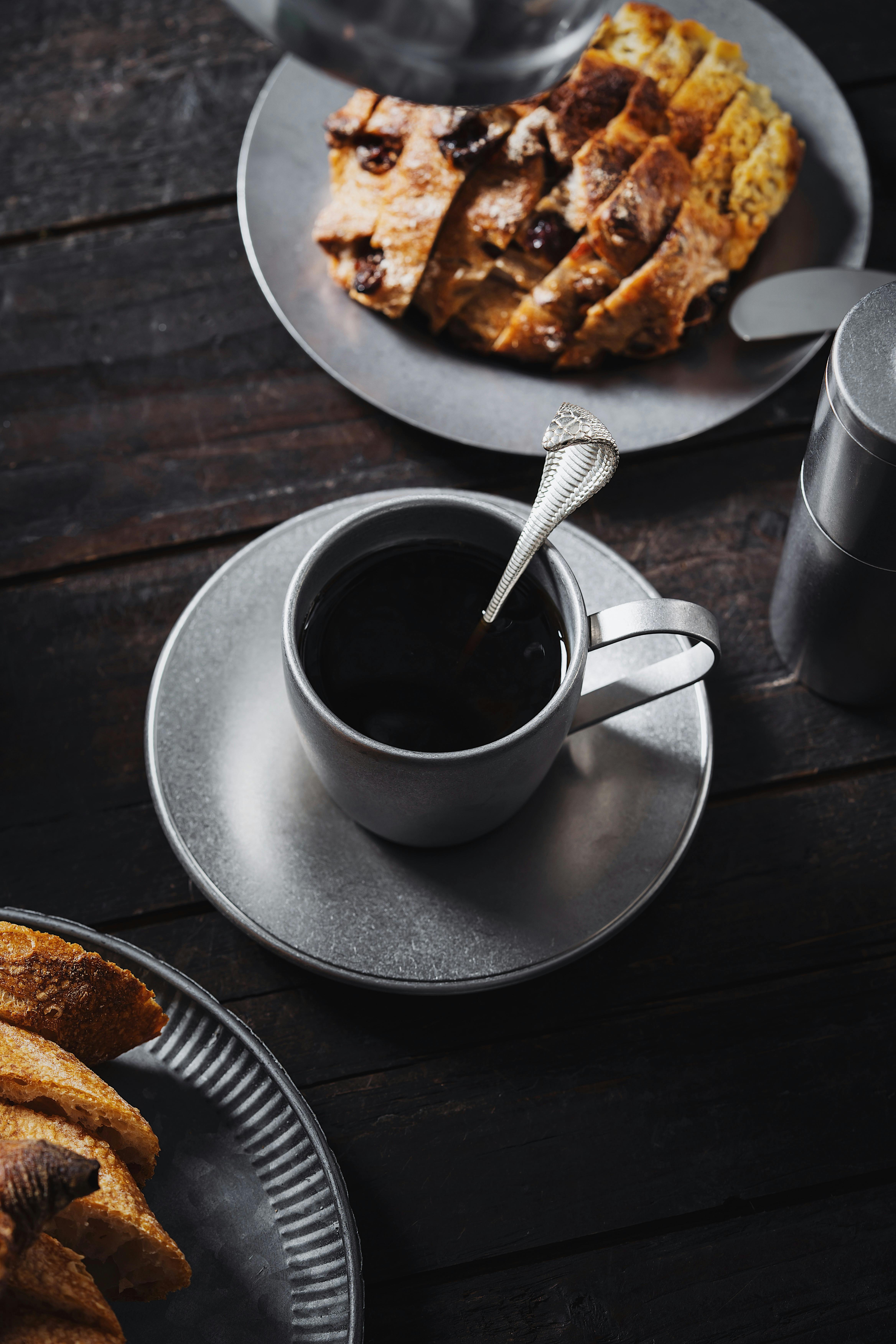 Silver Coffee Cup and a Cobra Spoon · Free Stock Photo