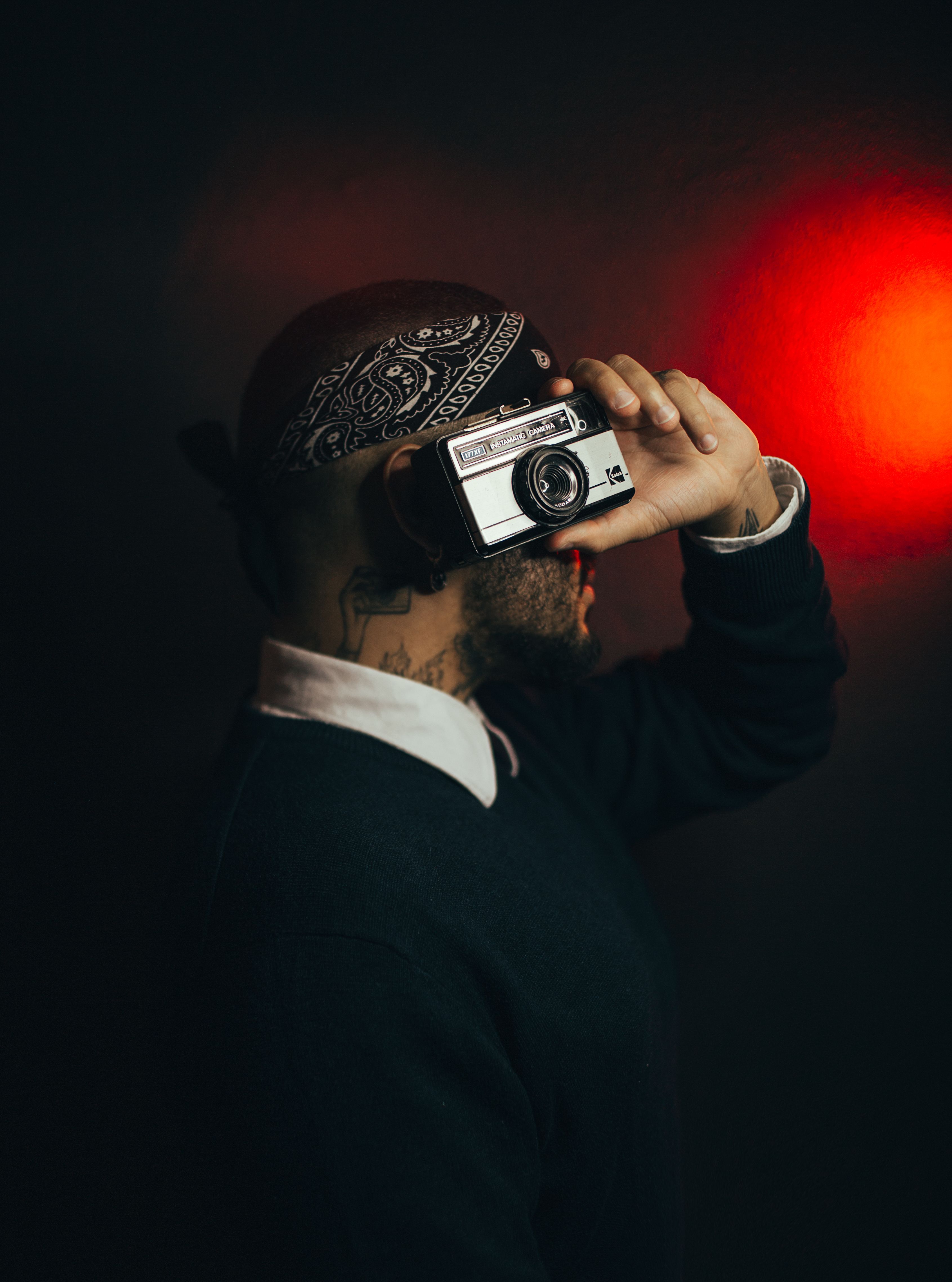 Man Holding a Camera next to His Face · Free Stock Photo