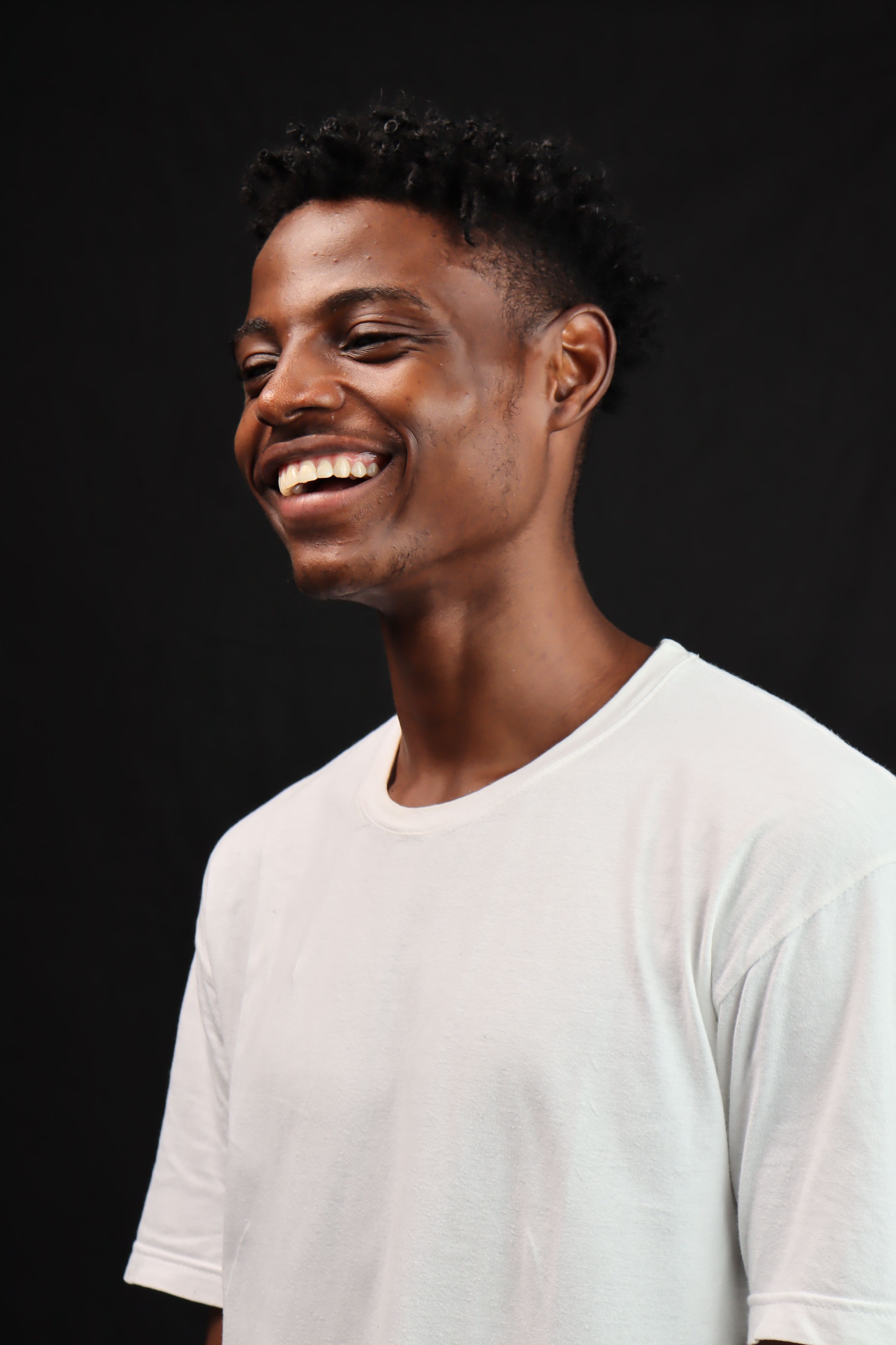 Portrait of Sitting Smiling Man with Bucket Hat · Free Stock Photo