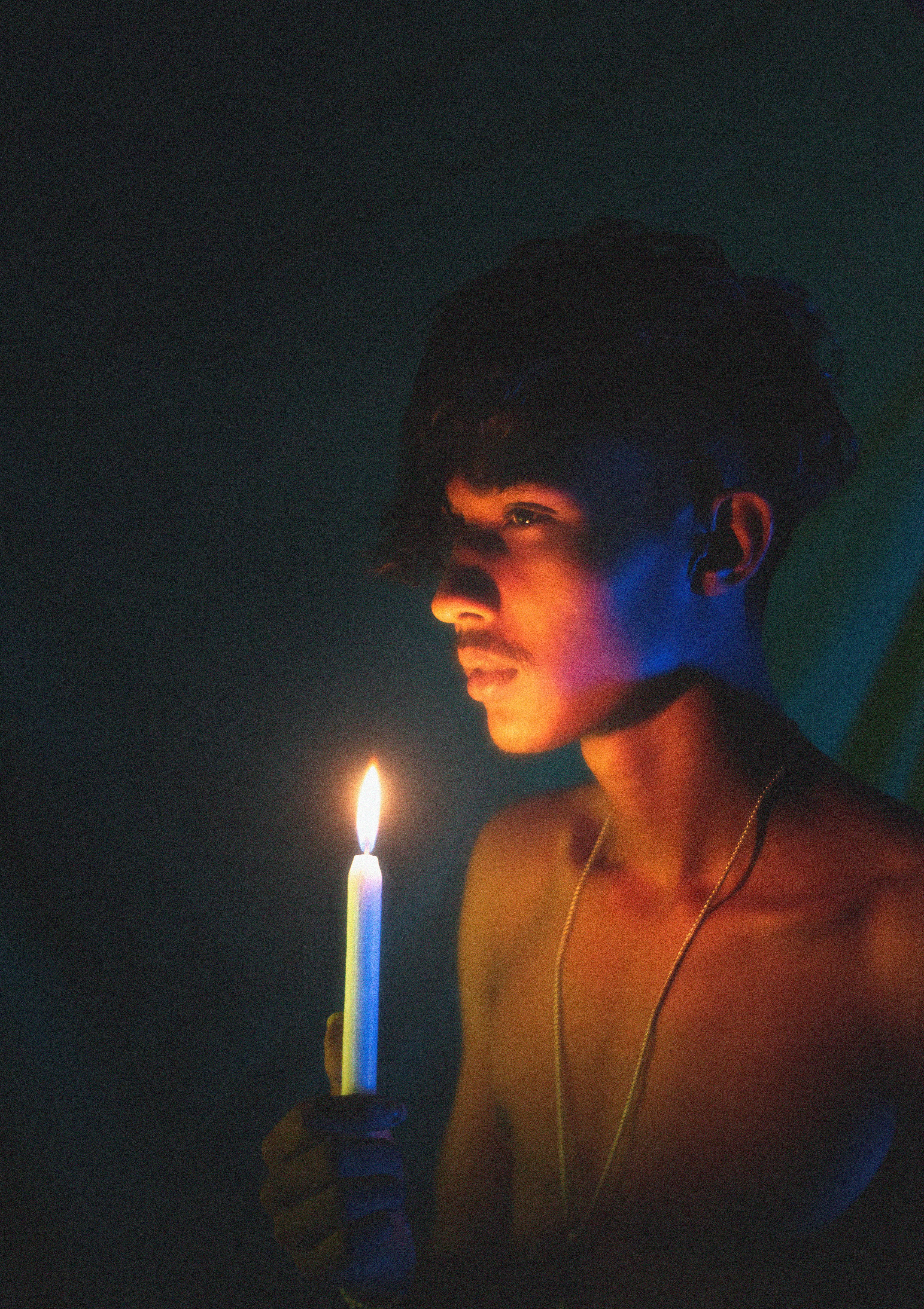 A man holding a candle in front of him · Free Stock Photo