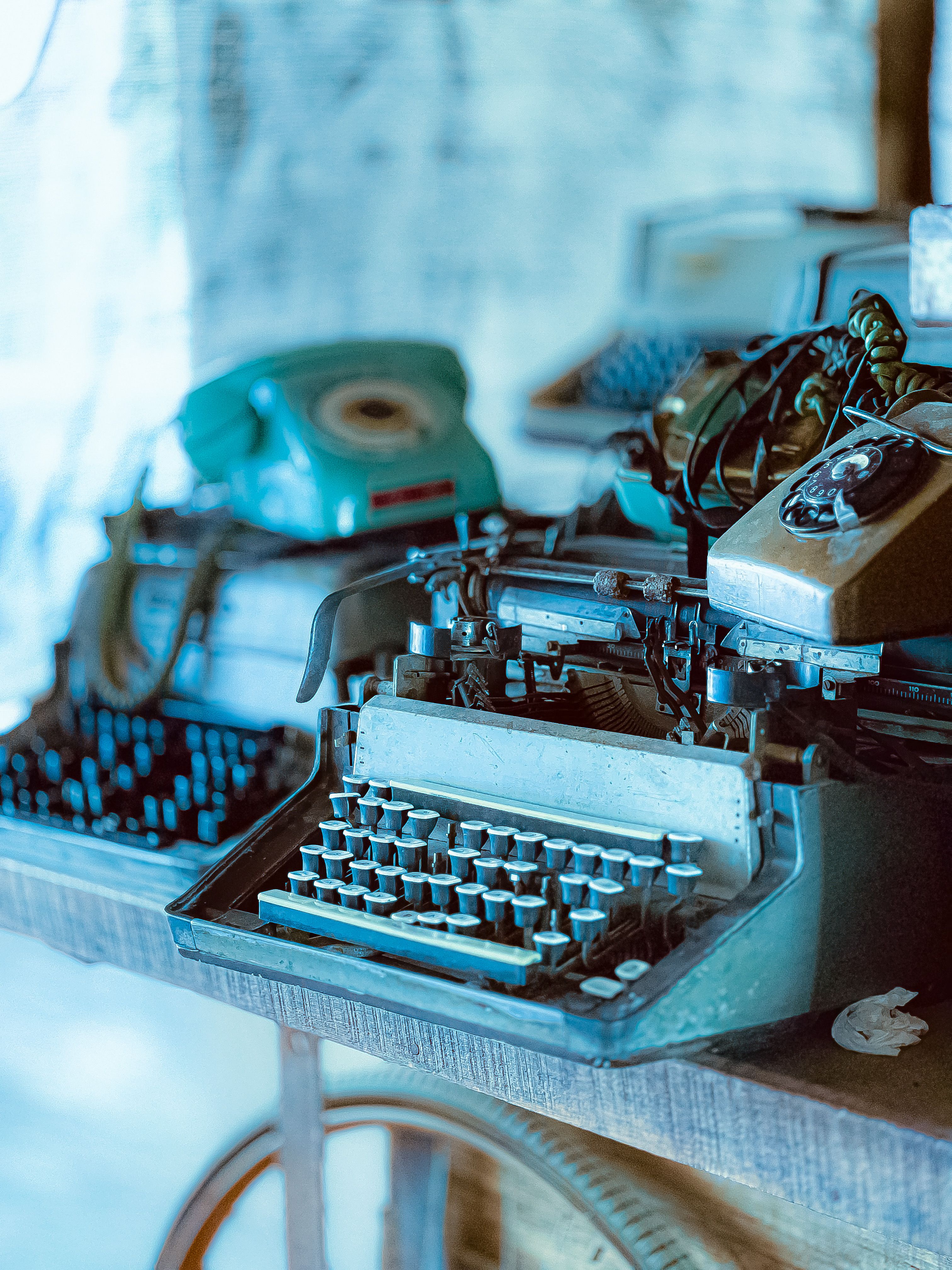 A Pile of Antique Typewriters and Telephones · Free Stock Photo