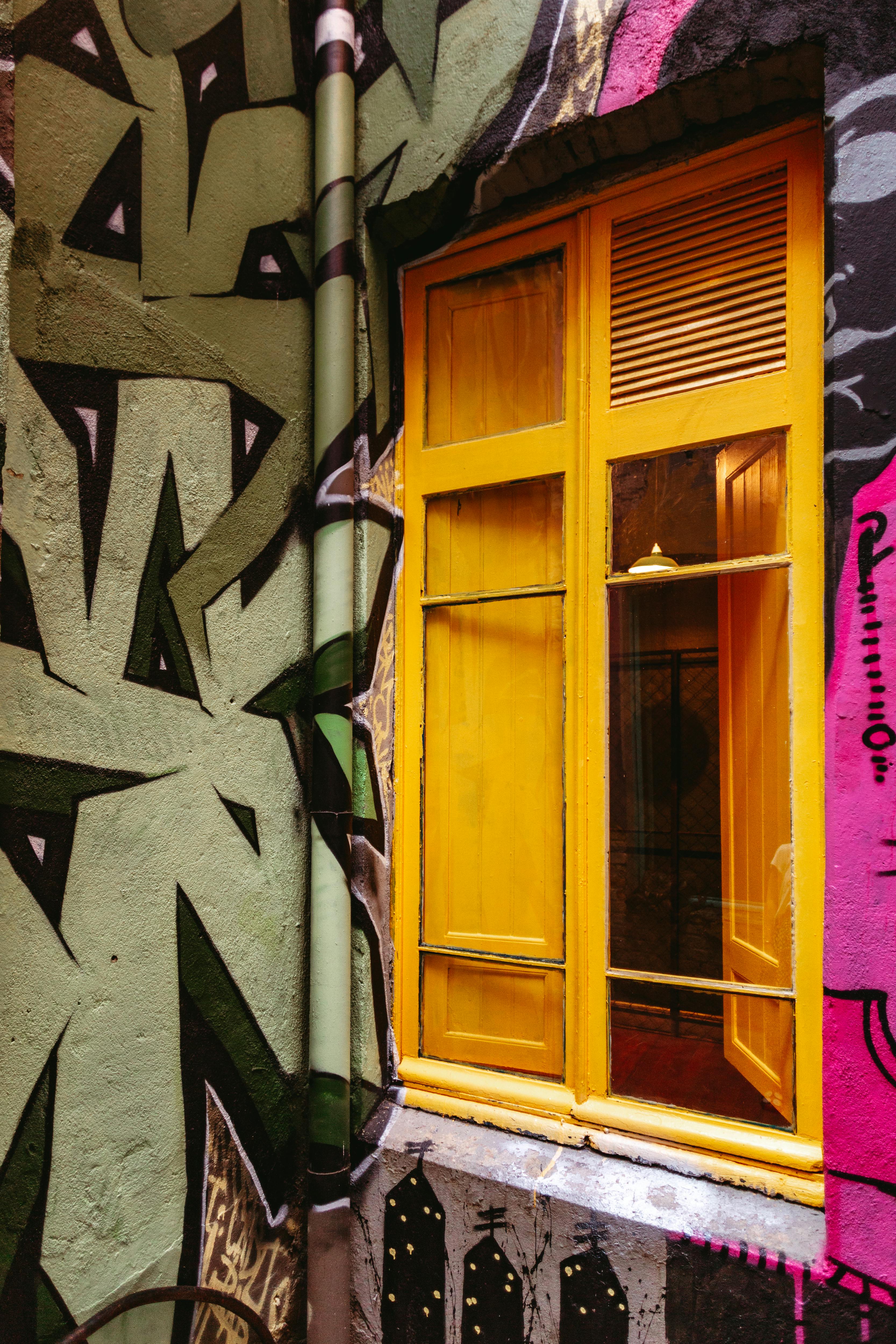 Yellow Window on Building with Graffiti Walls · Free Stock Photo