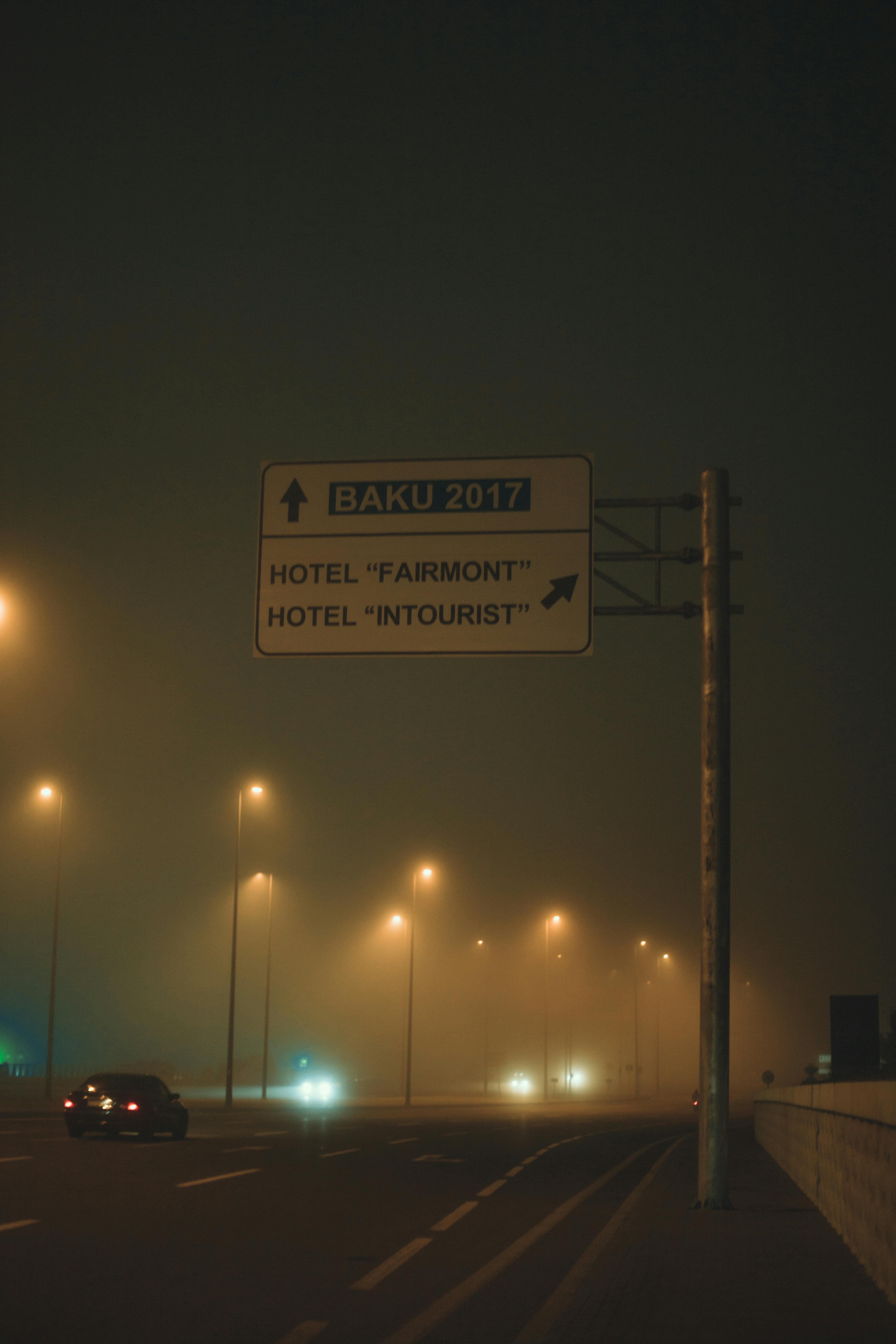 Directional Signs in Town at Night · Free Stock Photo