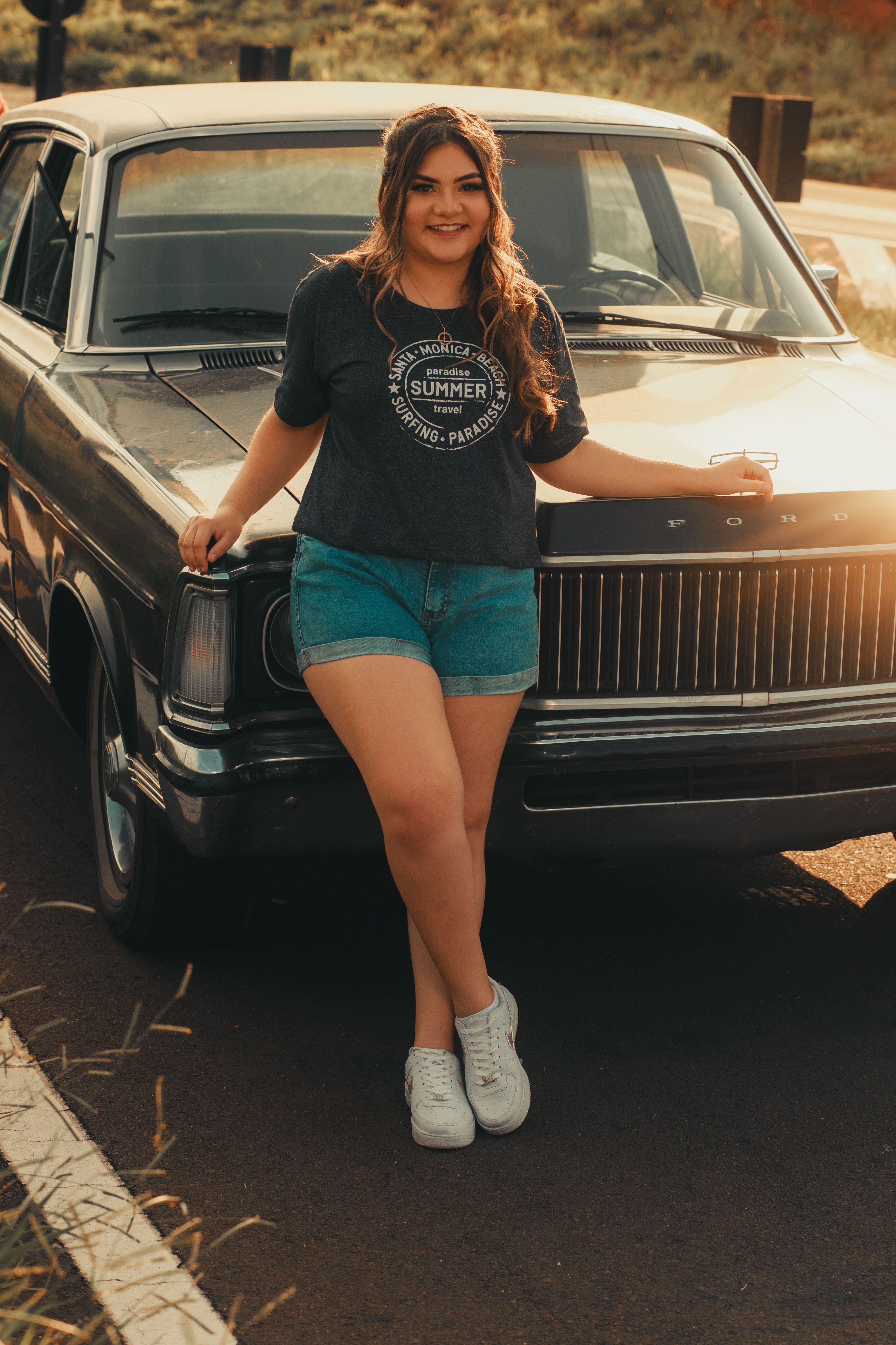 Smiling Woman Posing with Black Ford · Free Stock Photo