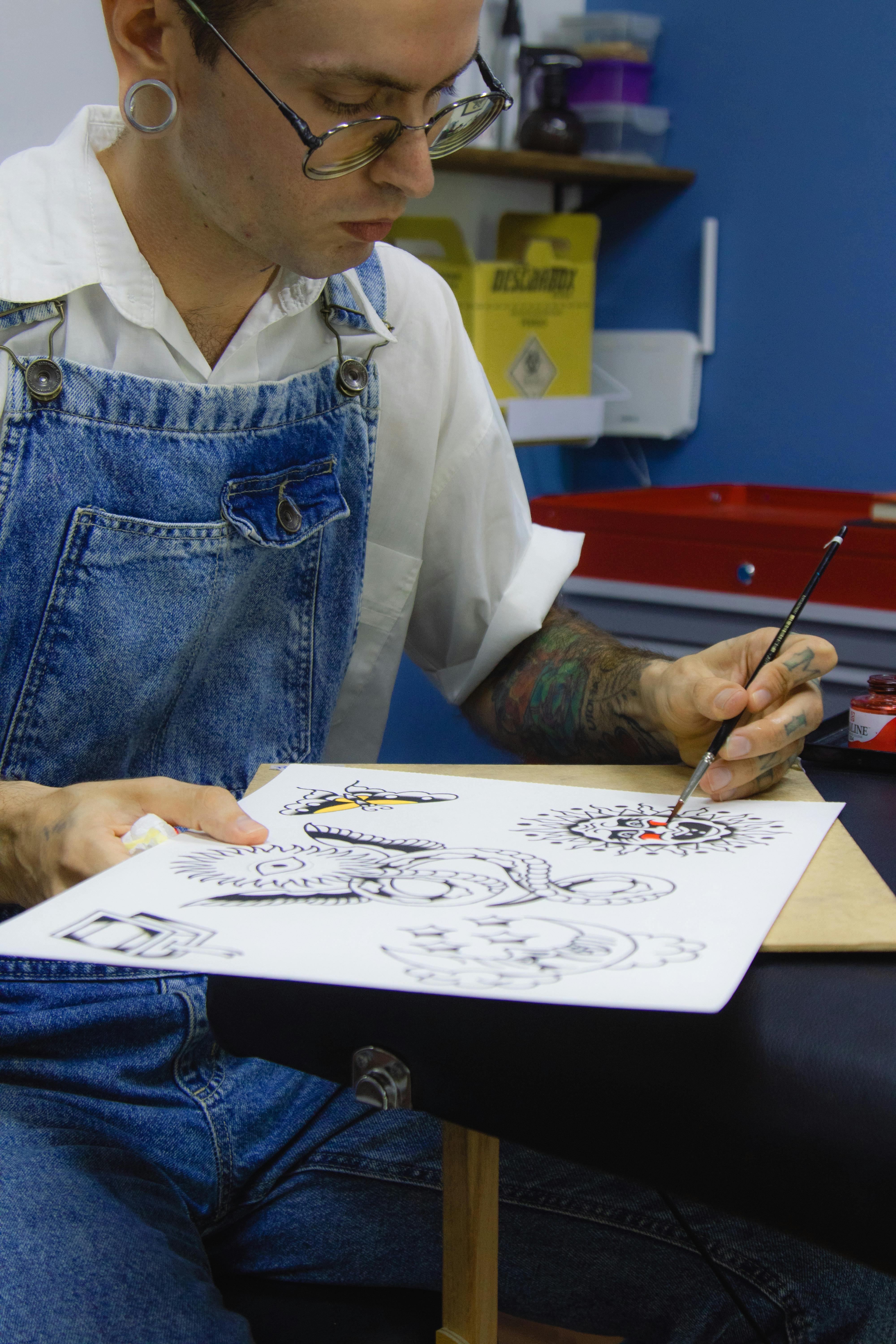 Man Drawing Tattoo Patterns · Free Stock Photo