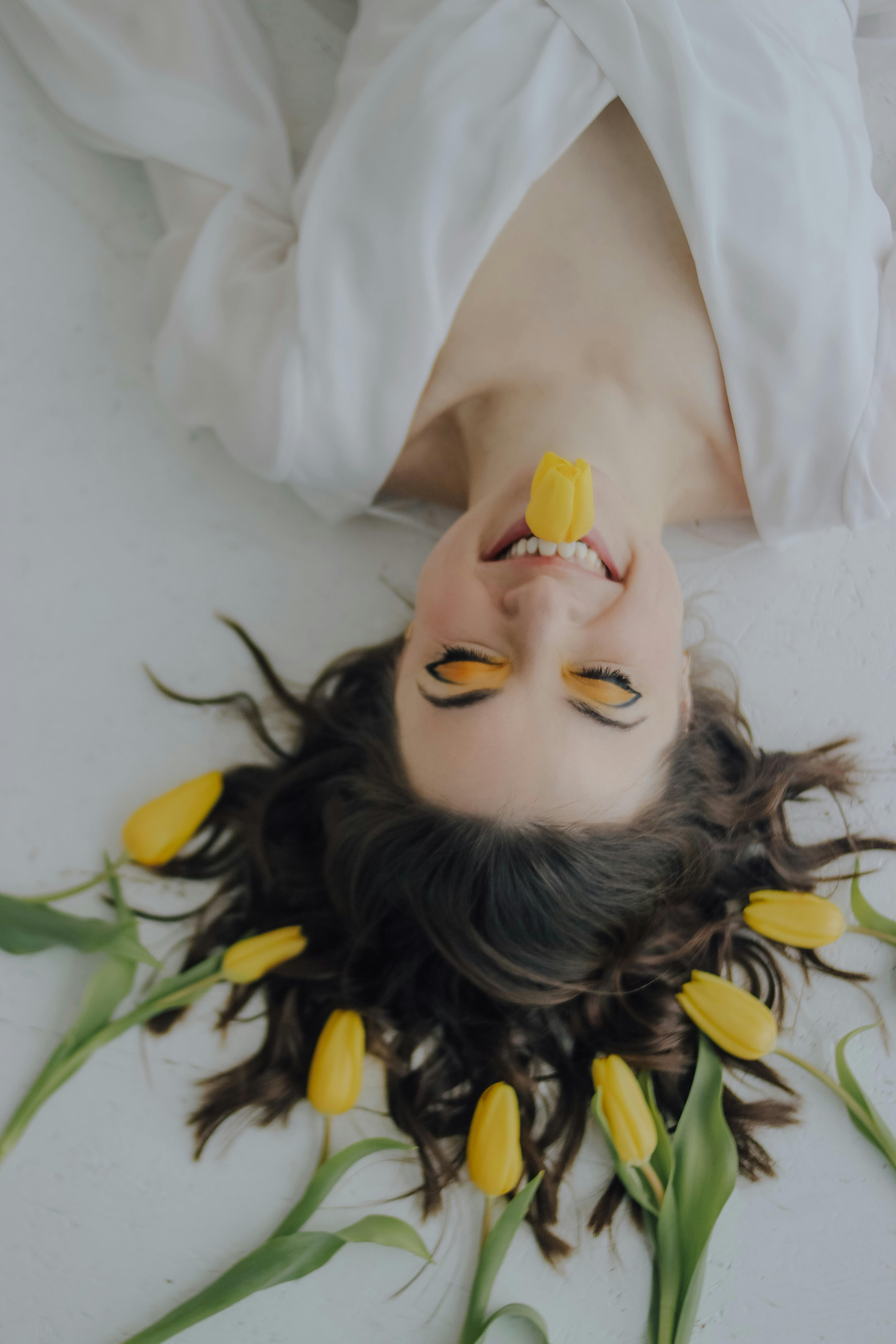 Beautiful Woman with Yellow Flower on Her Lips · Free Stock Photo