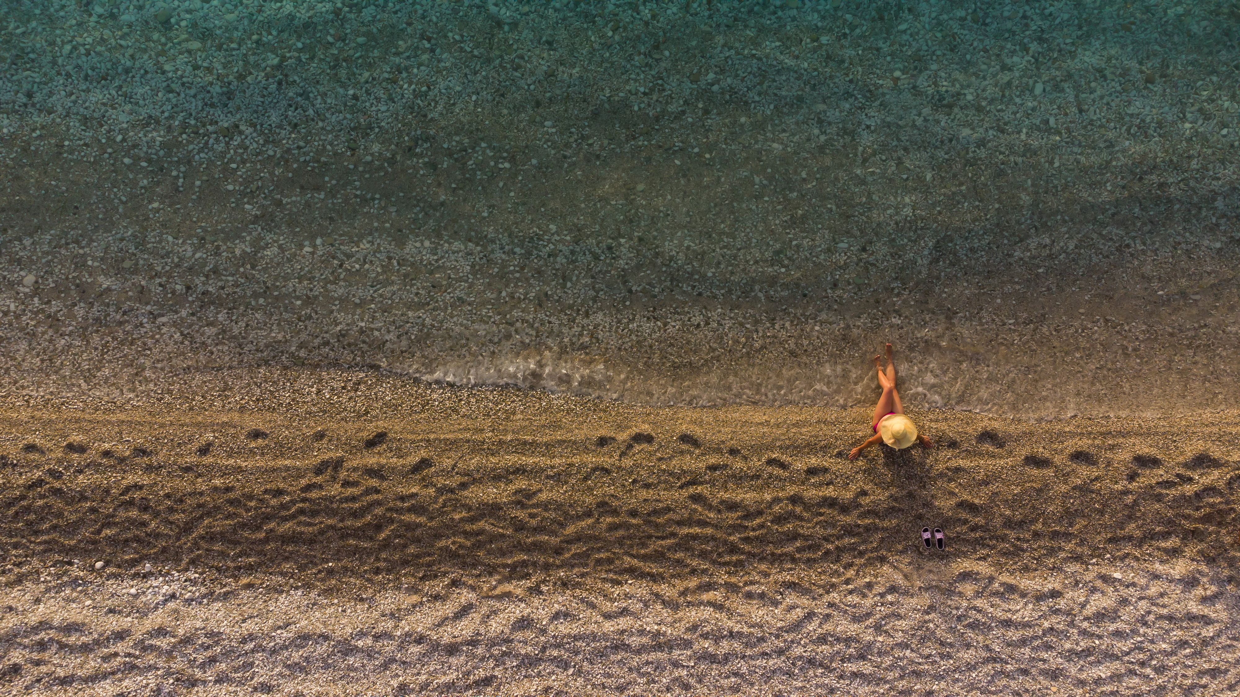Birds Eye View of Woman Sitting on Beach · Free Stock Photo