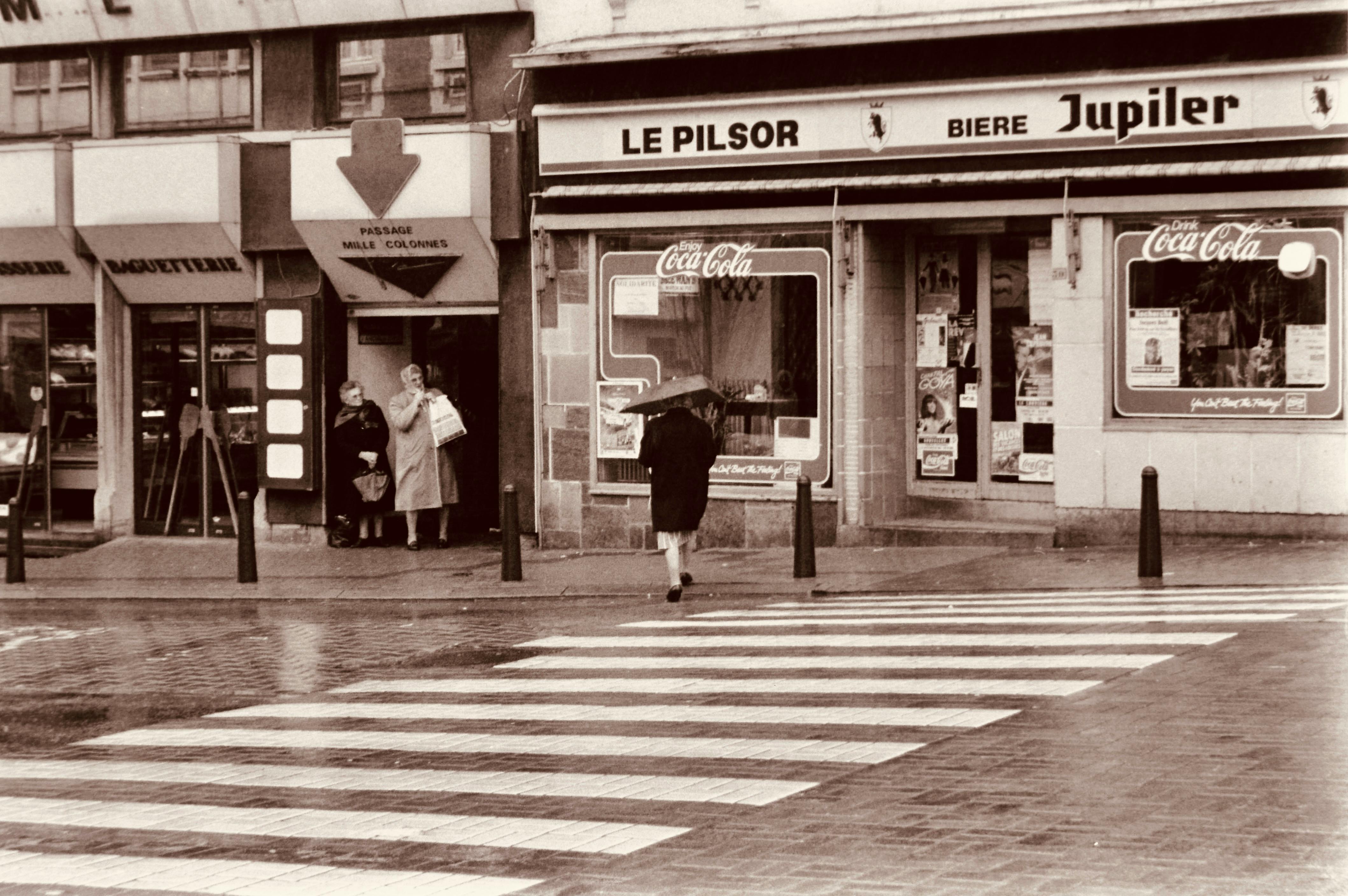 People Walking on the Street in Rain in Sepia · Free Stock Photo