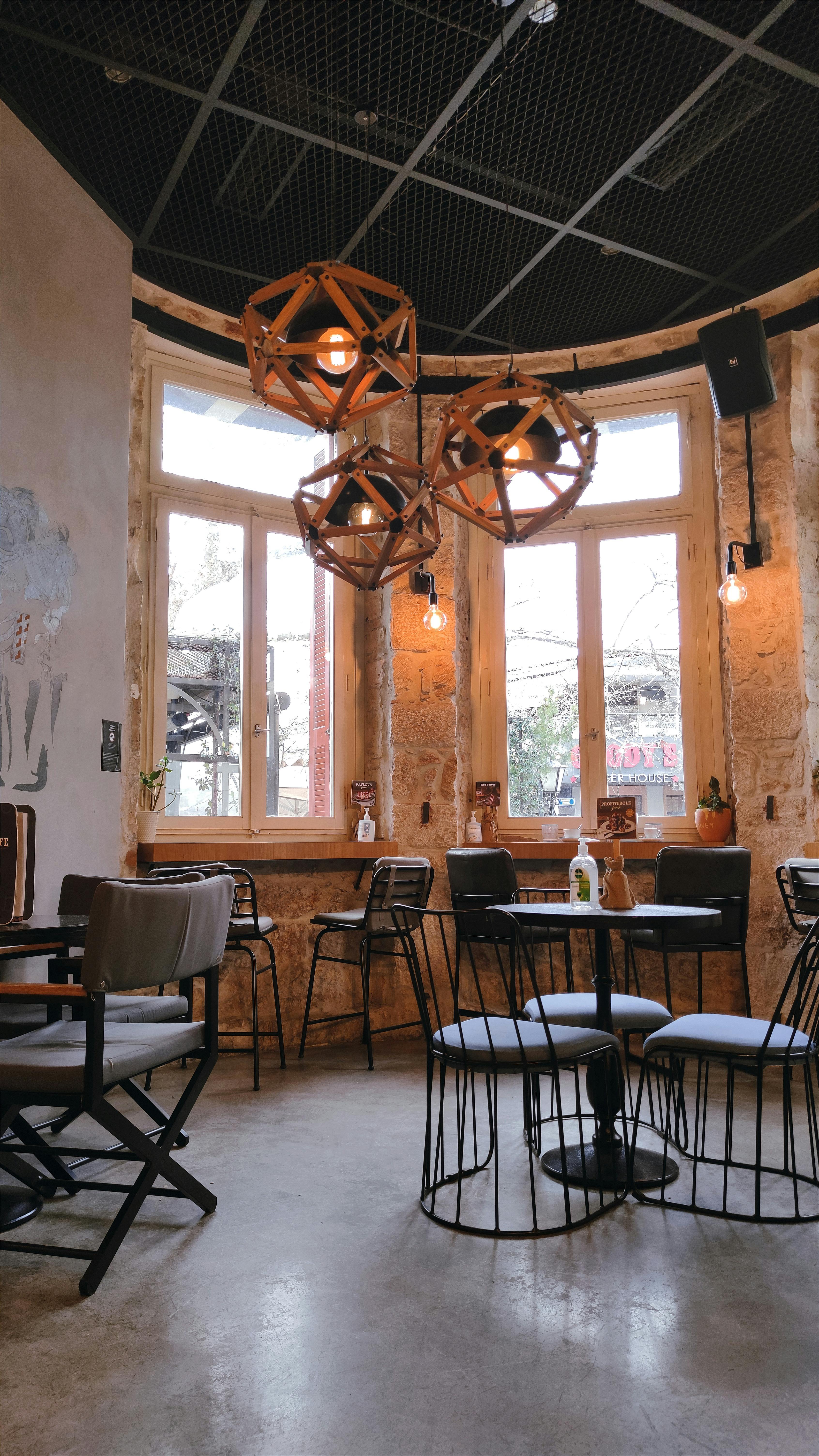 Round Cafe Interior with Wooden Lamps · Free Stock Photo