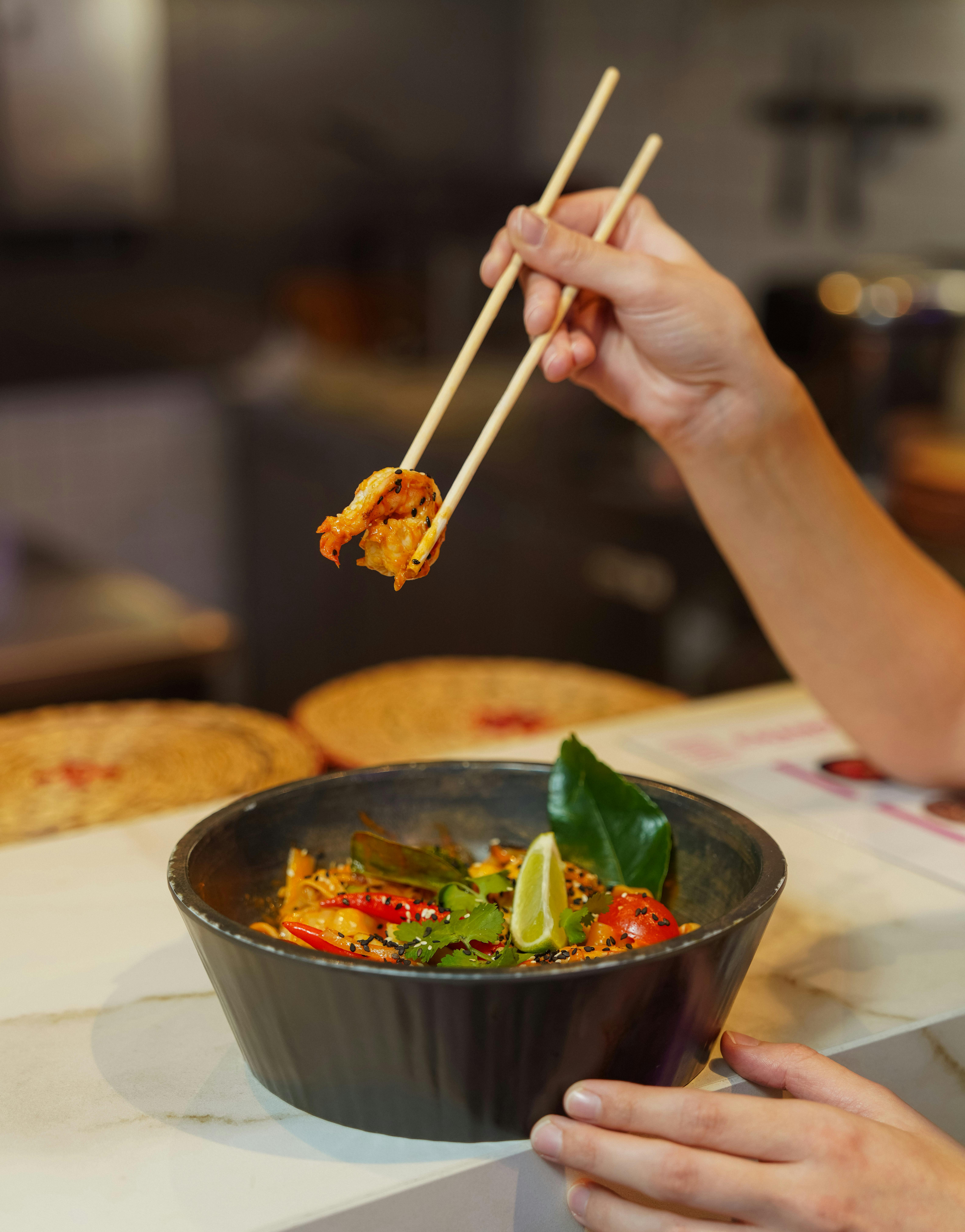Hands Holding Food in Chopsticks · Free Stock Photo