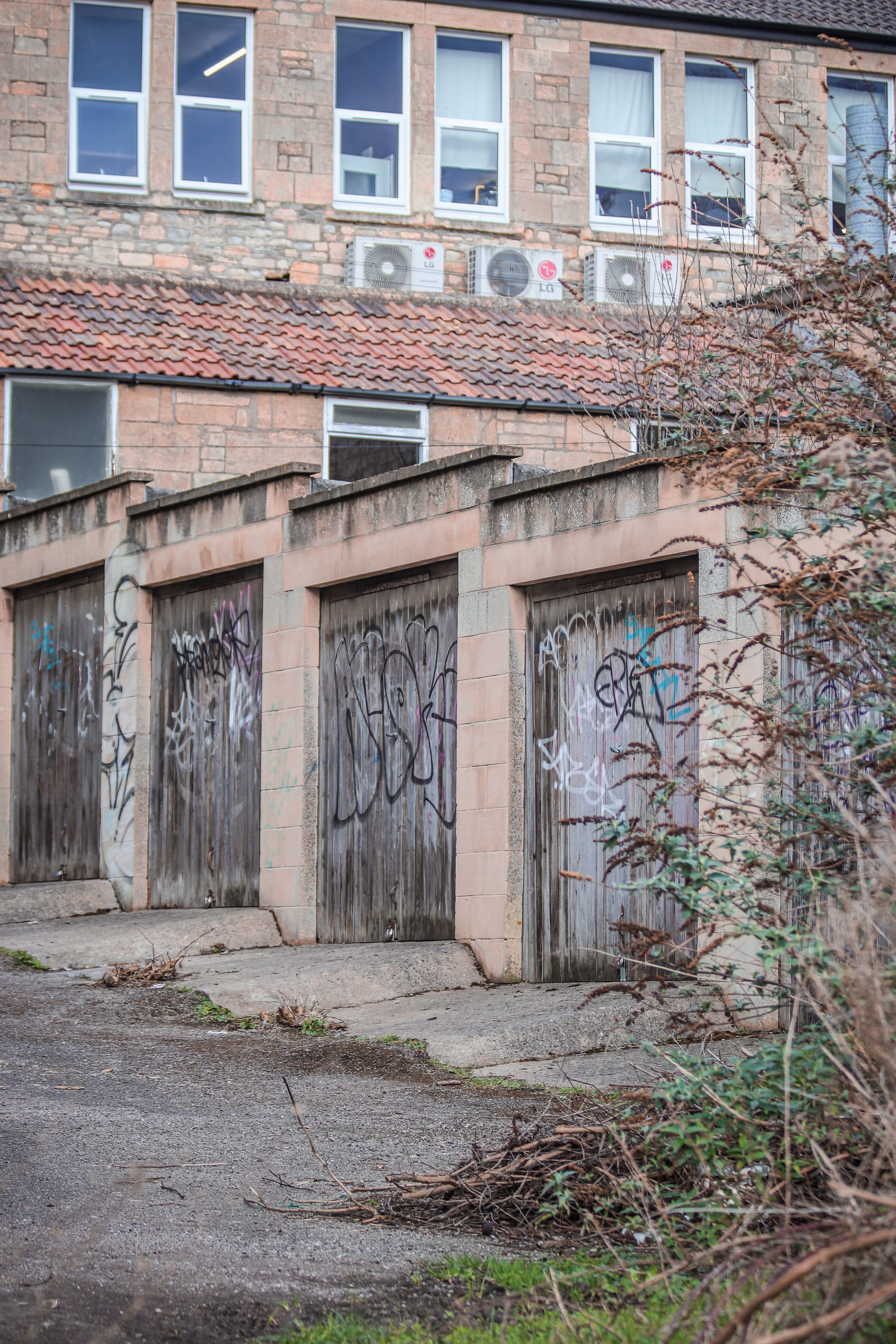 Old Garages in front of Residential Buildings · Free Stock Photo