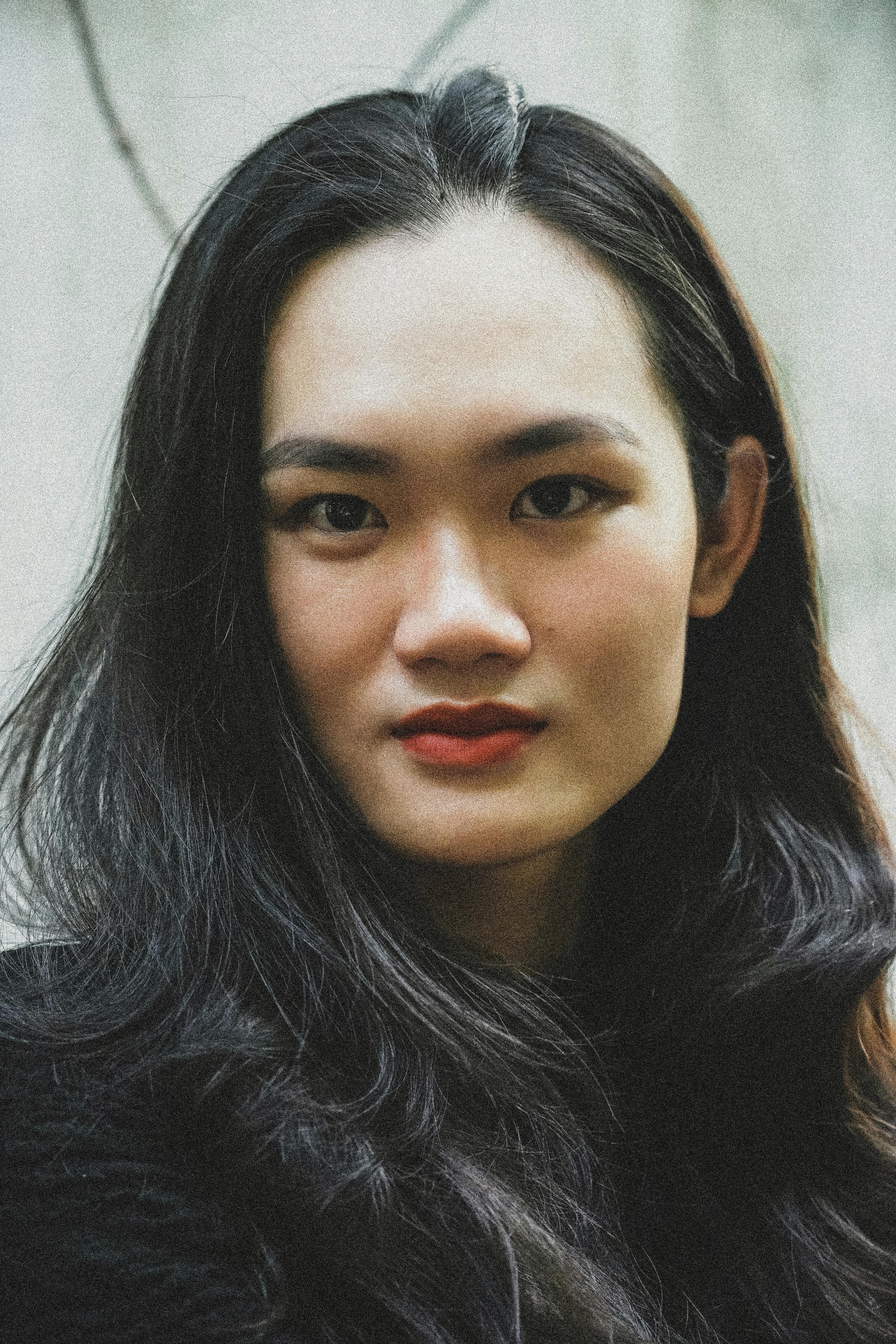 Grainy Portrait of Woman in Long Black Hair · Free Stock Photo