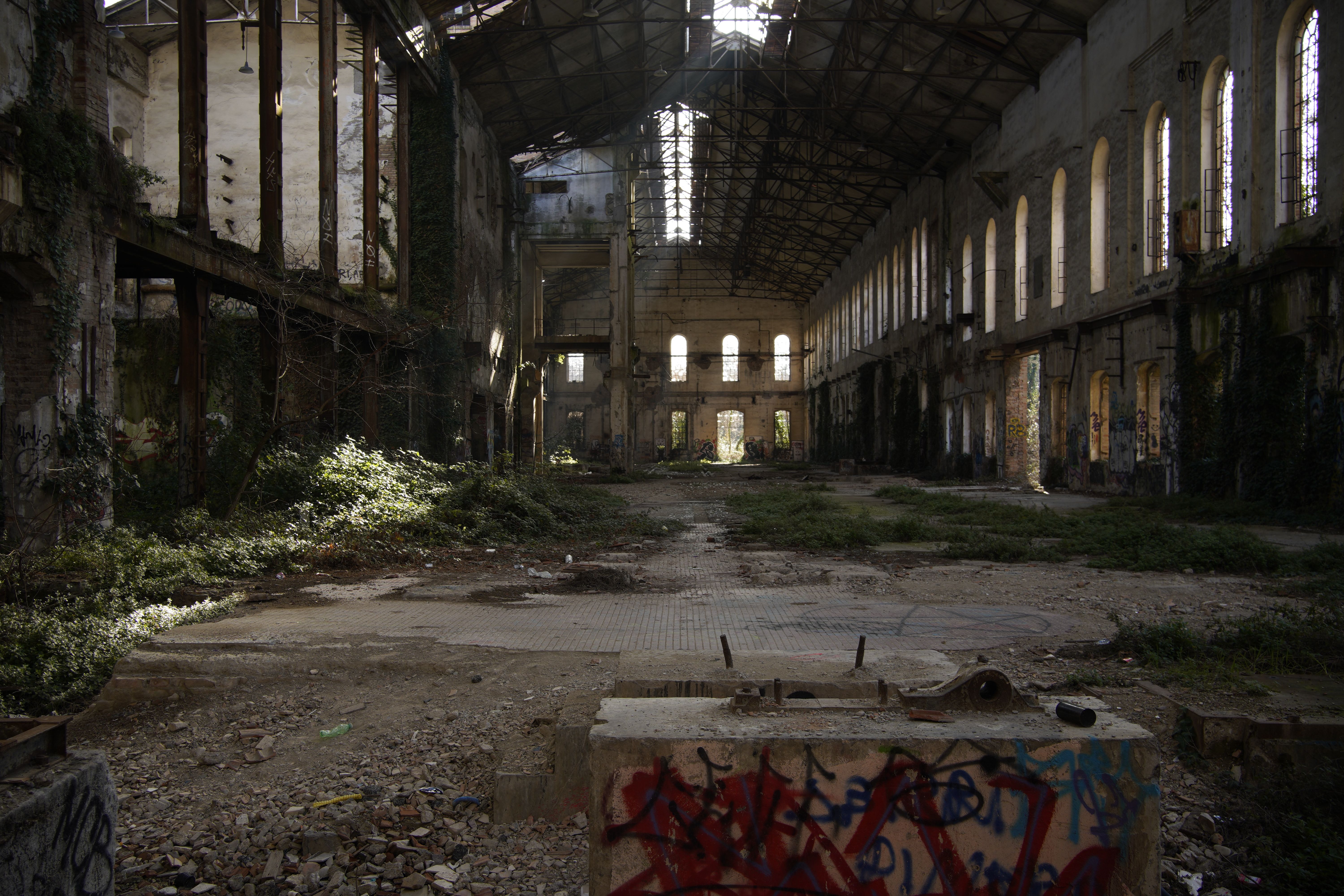 Two Men Standing on Brown Floor Inside Wrecked Building · Free Stock Photo