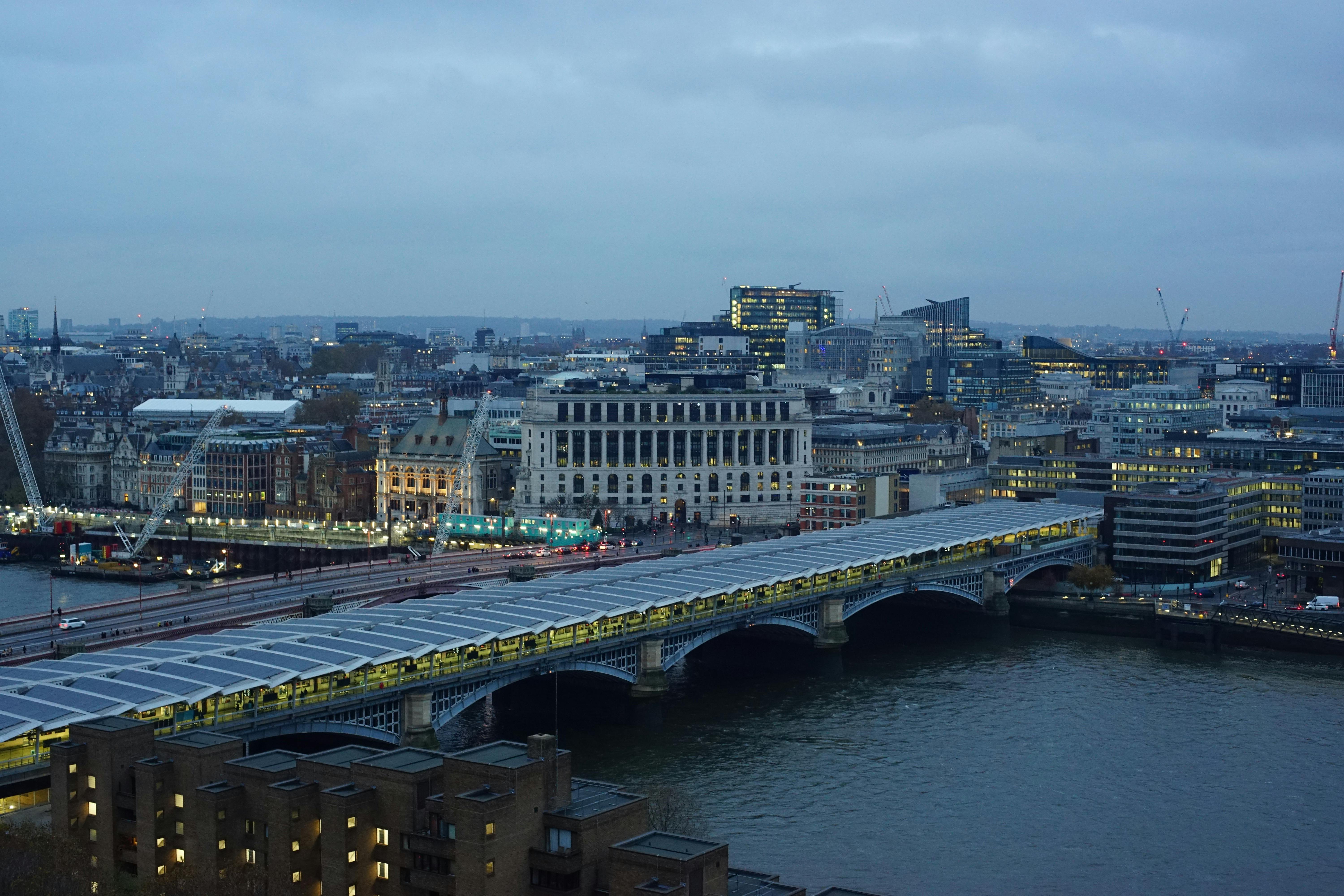 City Bridge and Buildings in Downtown near River · Free Stock Photo