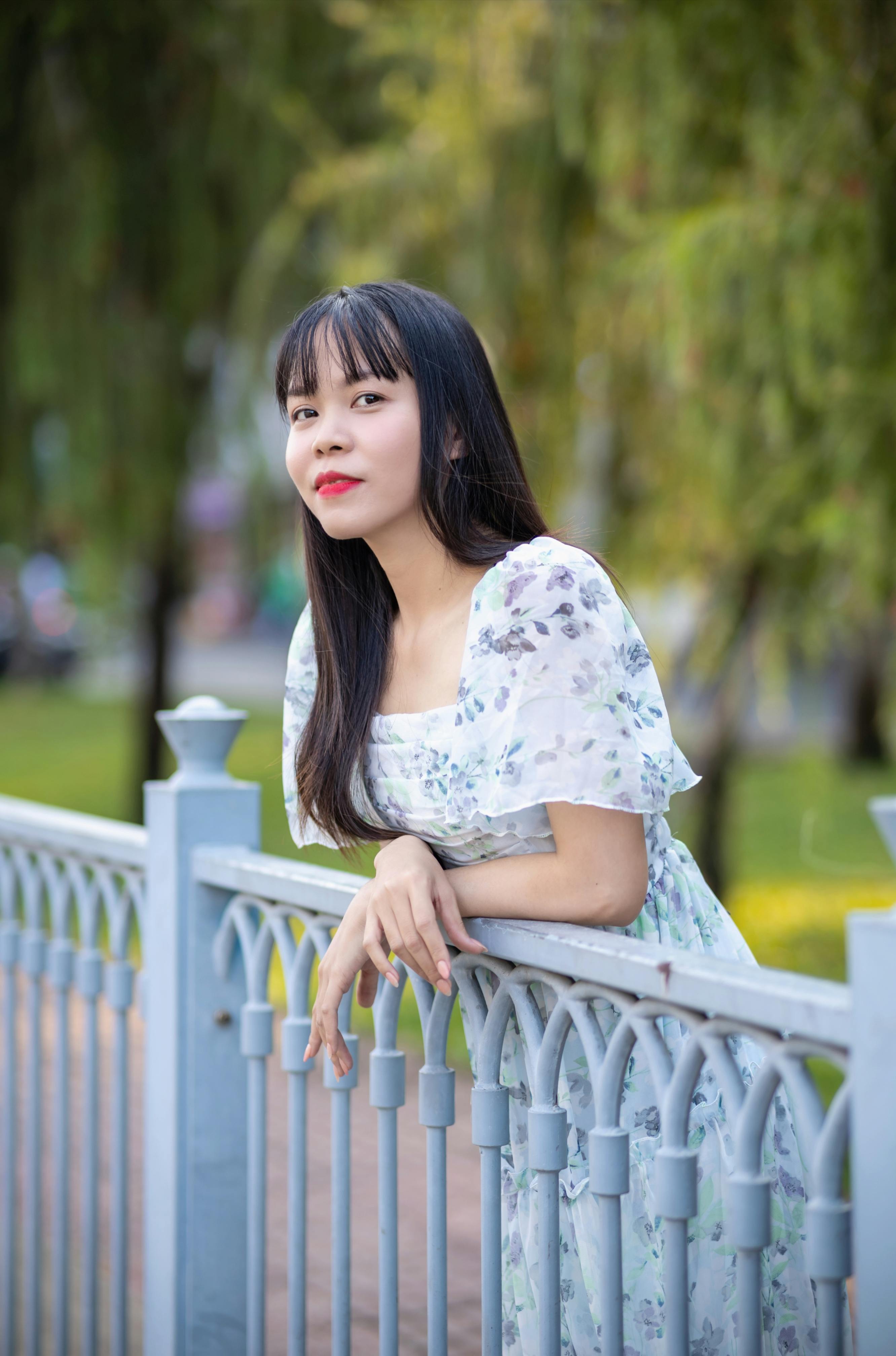 Woman in Black Leaning against Railing · Free Stock Photo