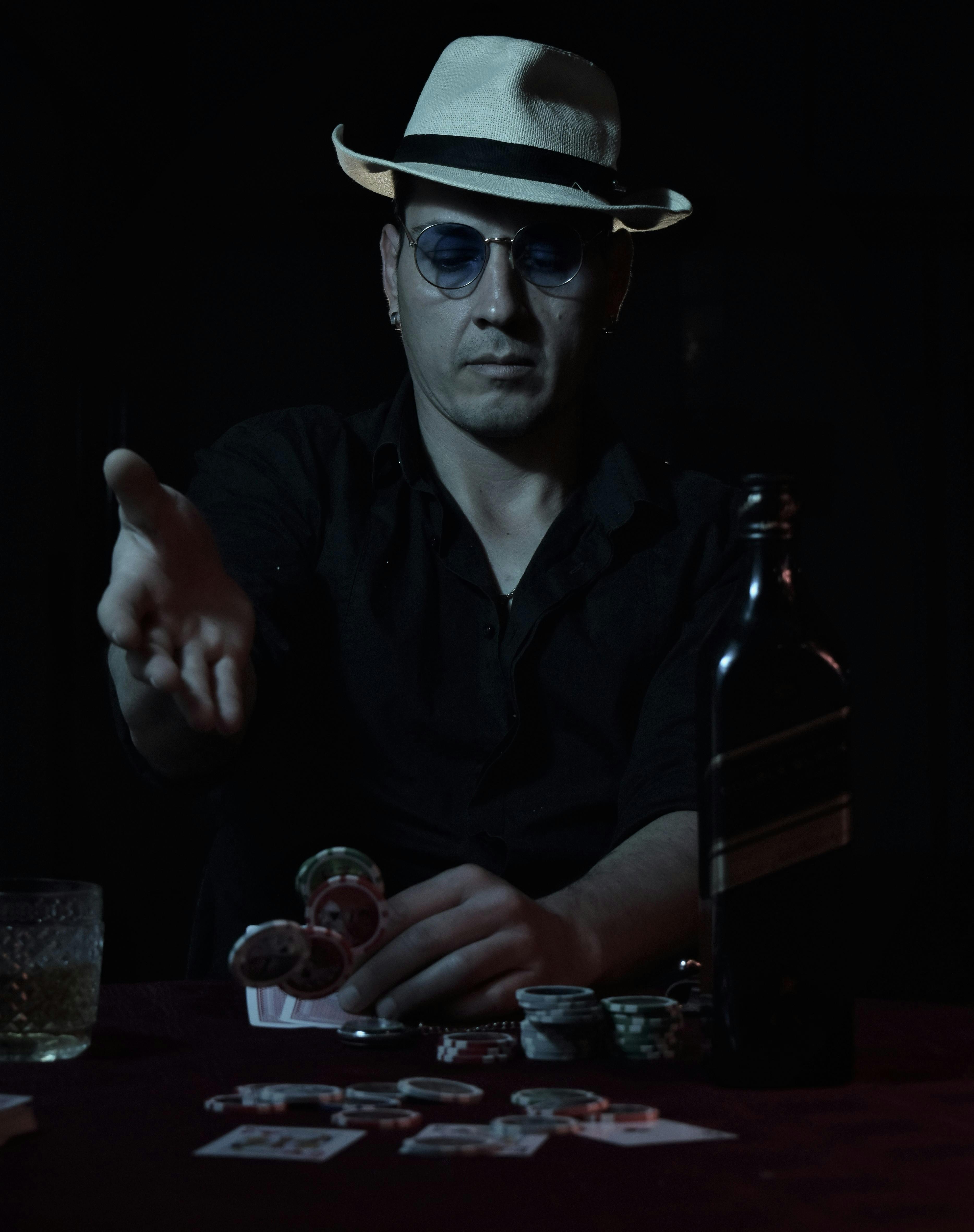 Man Throwing Poker Chips on Table · Free Stock Photo