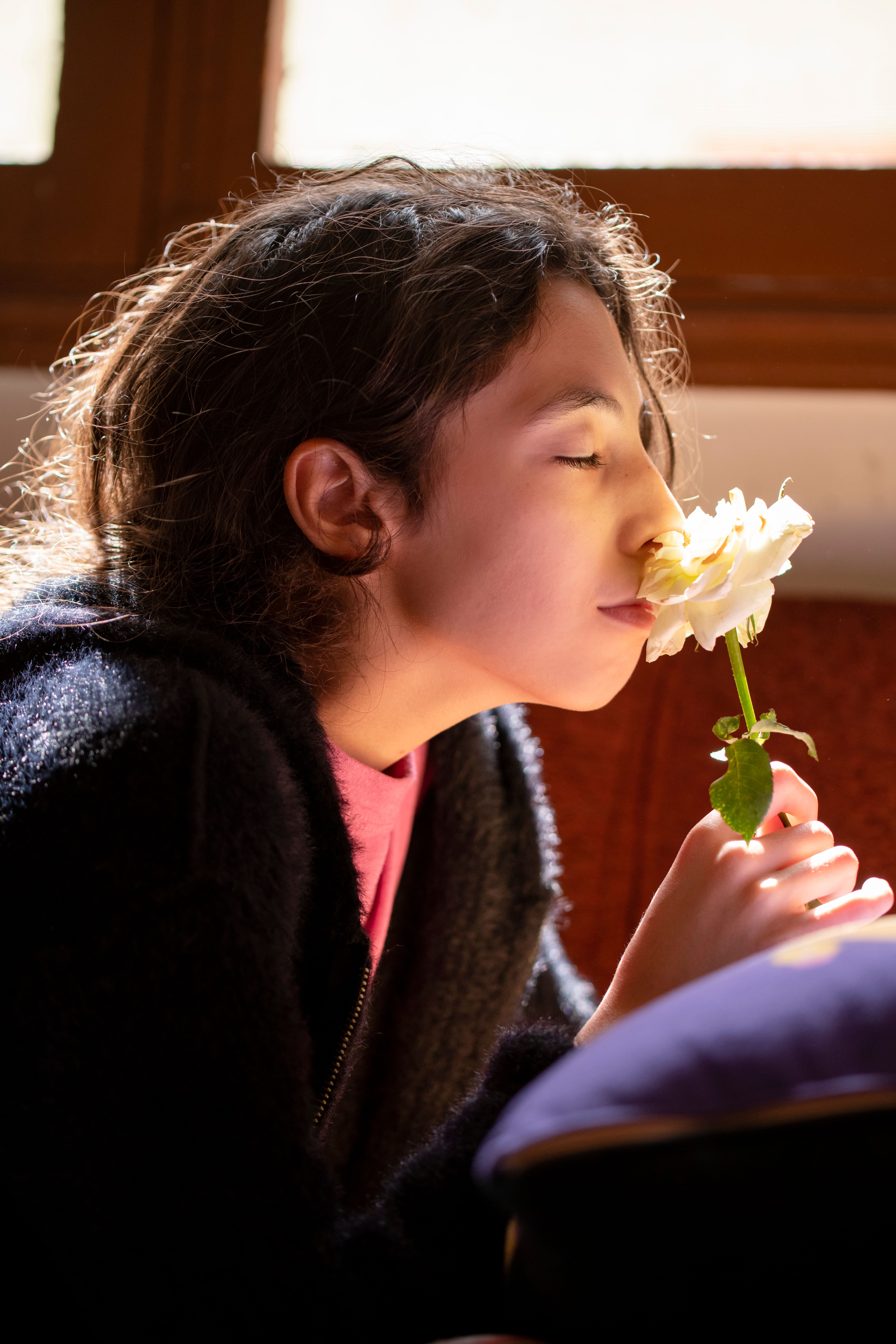 Woman Enjoying the Scent of a Flower · Free Stock Photo