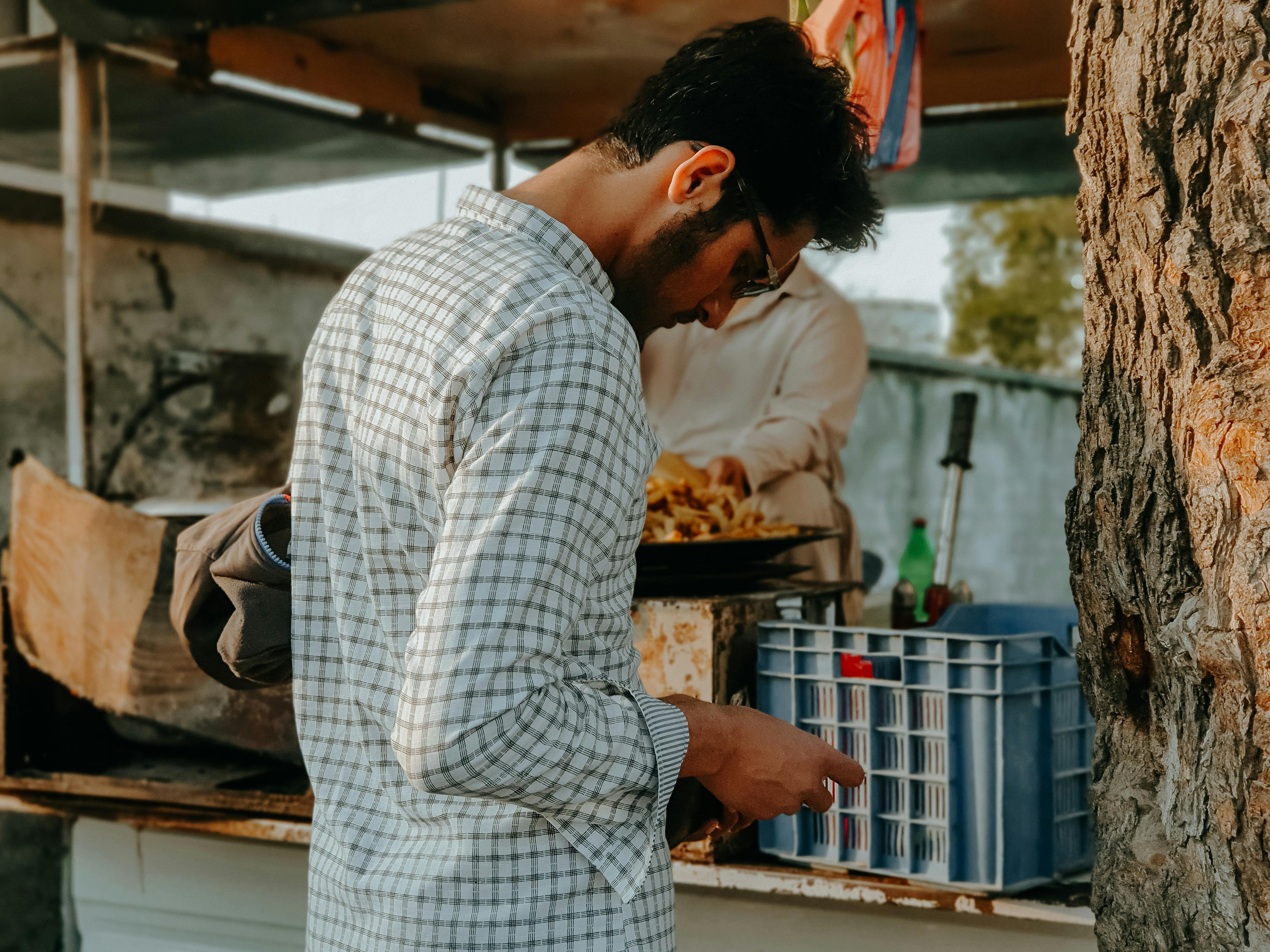 Photo of Two Men Standing at a Street Food Stall · Free Stock Photo