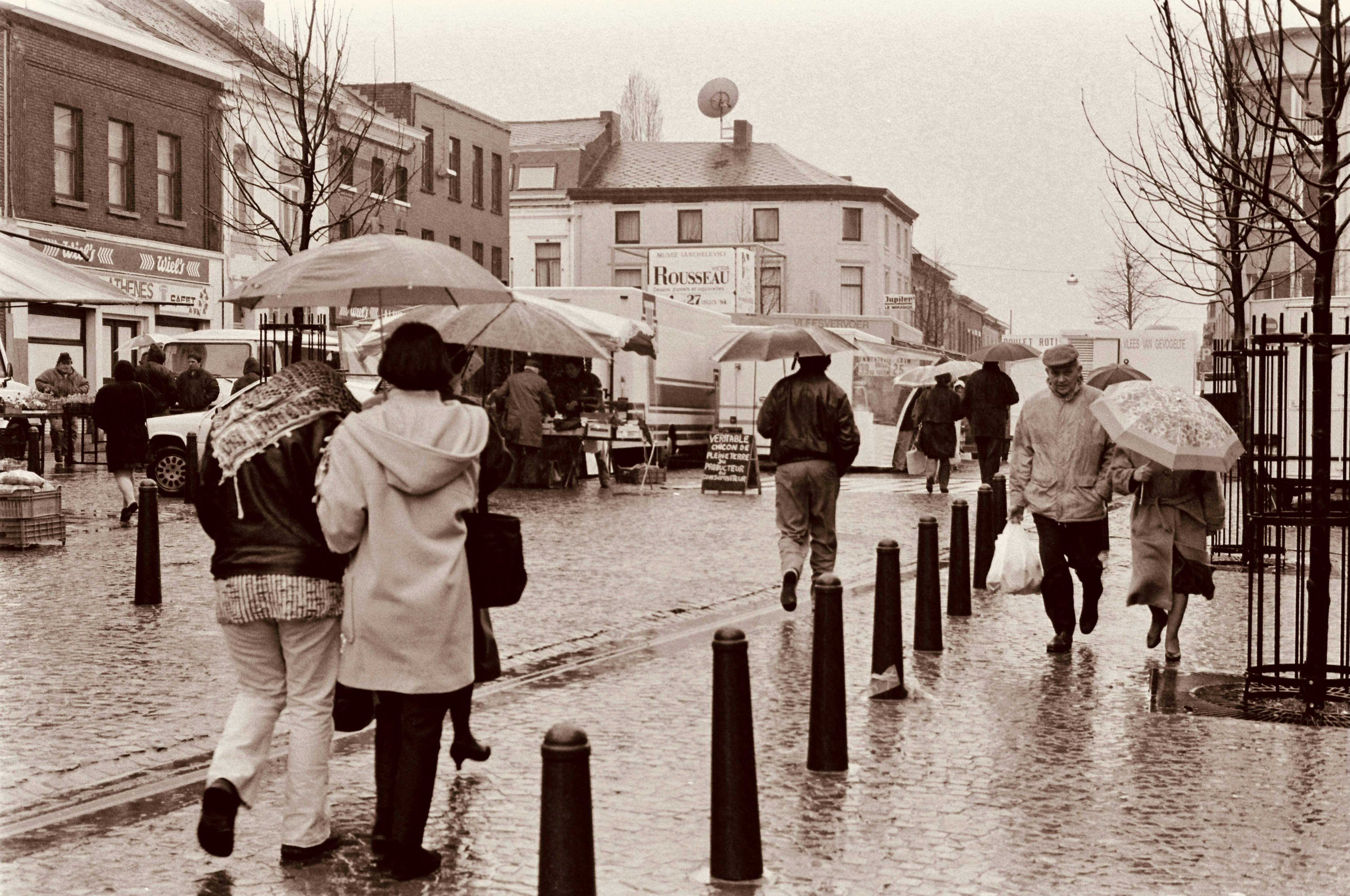 People Walking on the Street in Rain in Sepia · Free Stock Photo