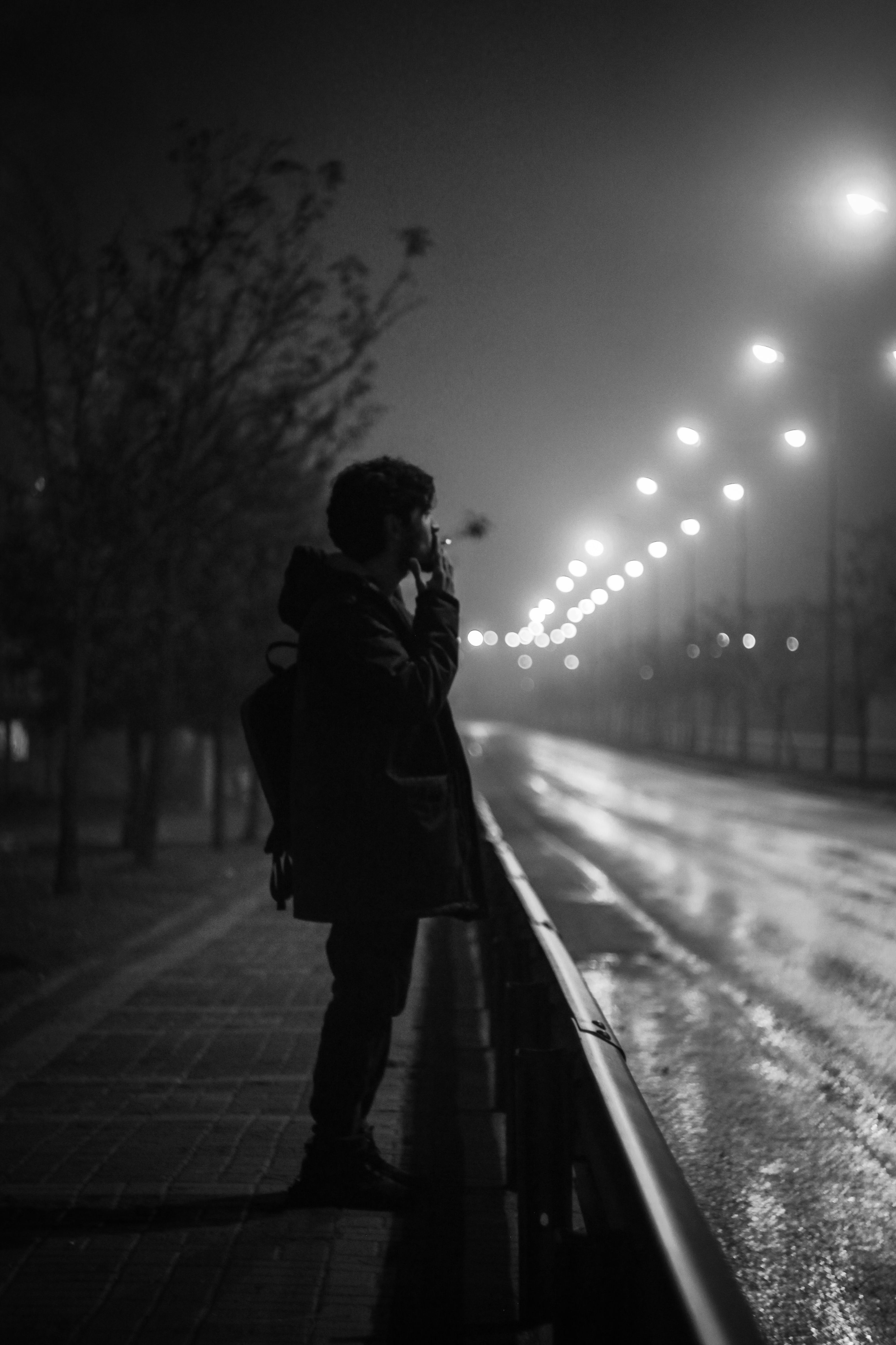 Man Smoking Cigarette on Sidewalk · Free Stock Photo