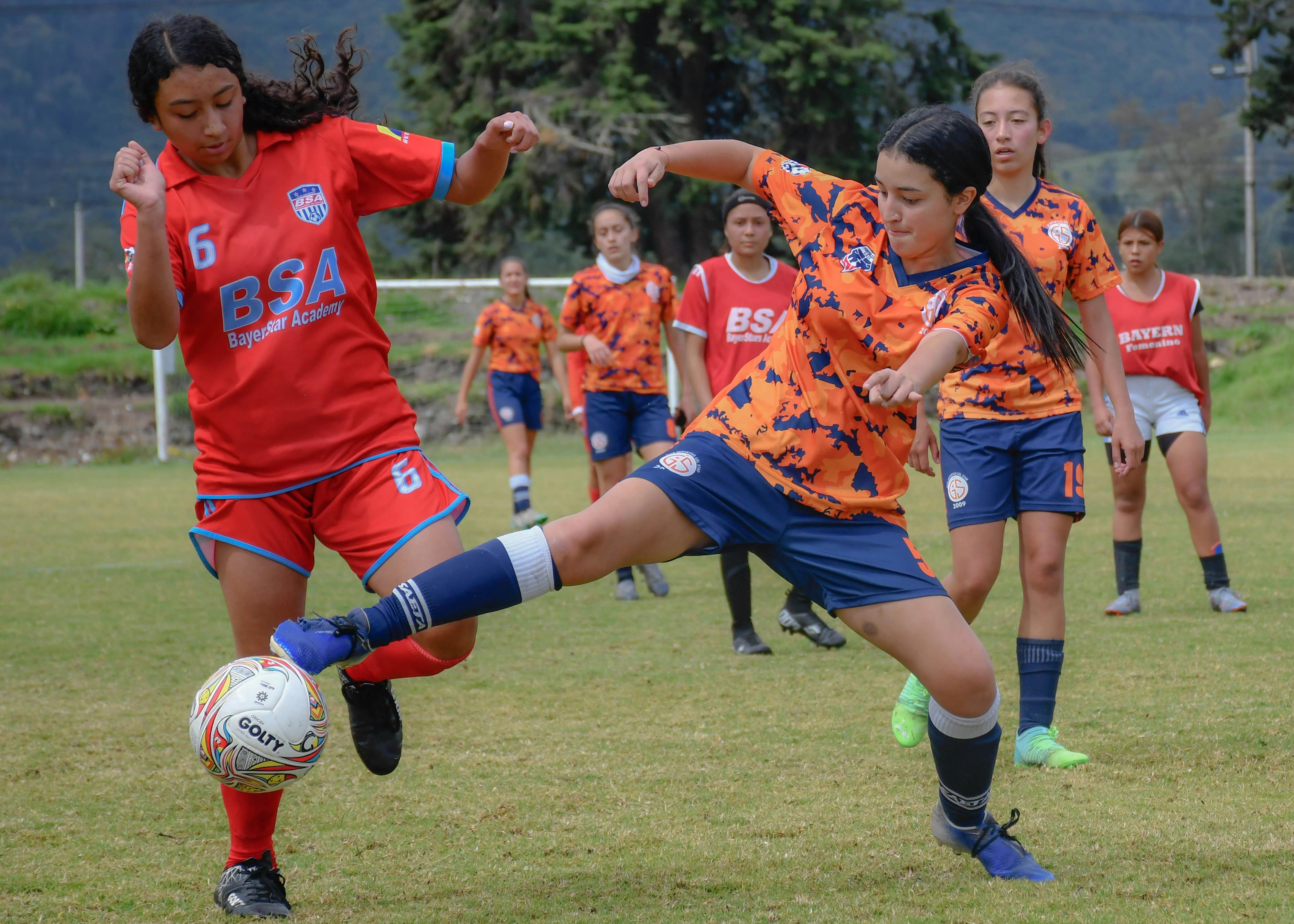 Teenage Girls Kicking a Football · Free Stock Photo