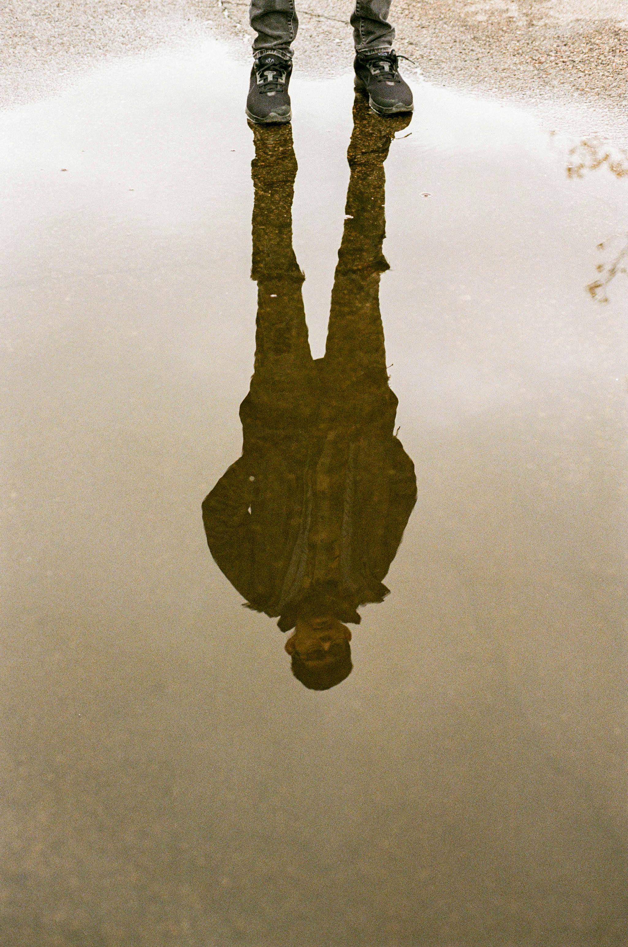 Man Reflecting in a Puddle · Free Stock Photo