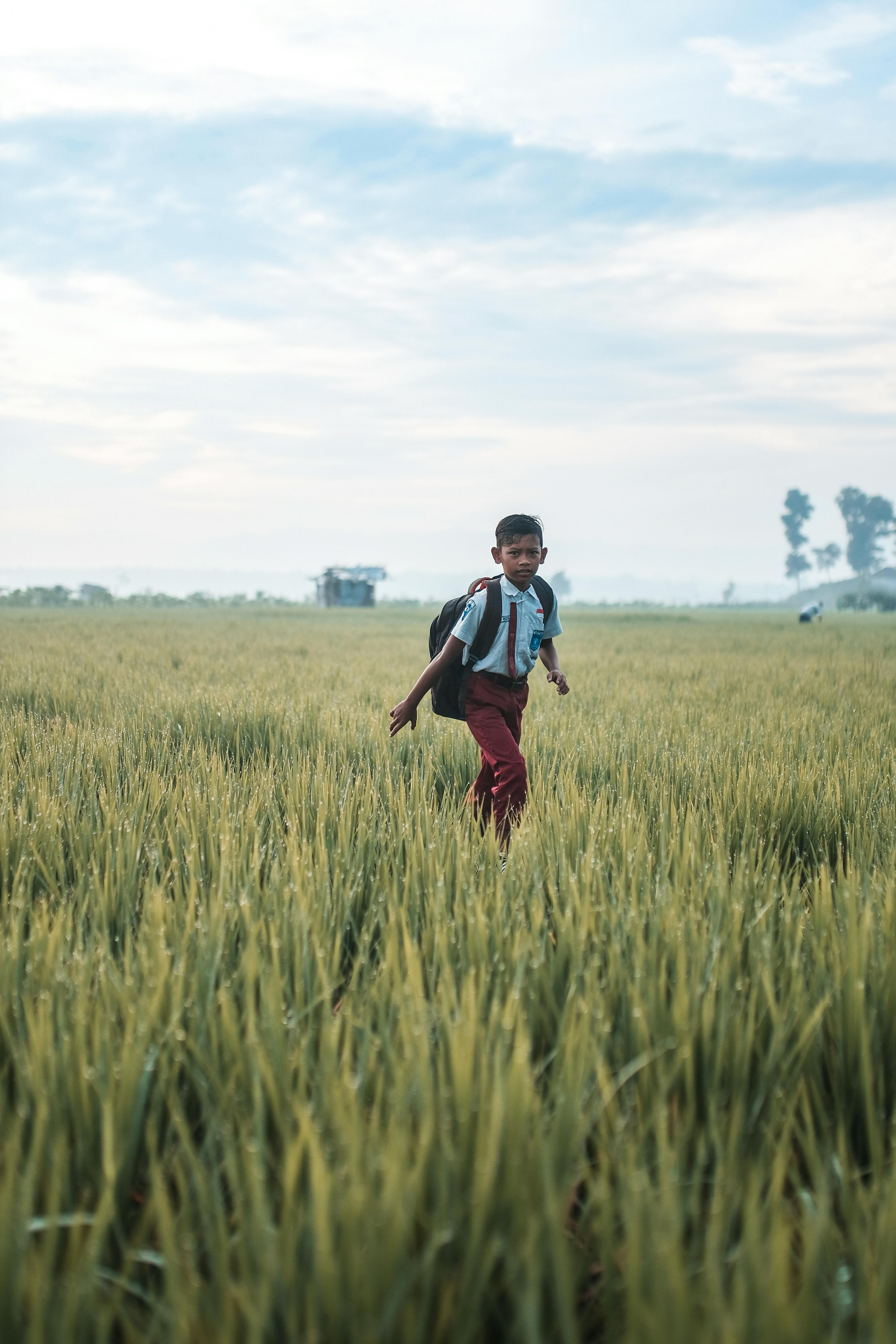 Girl in School Uniform Throwing Her Backpack · Free Stock Photo
