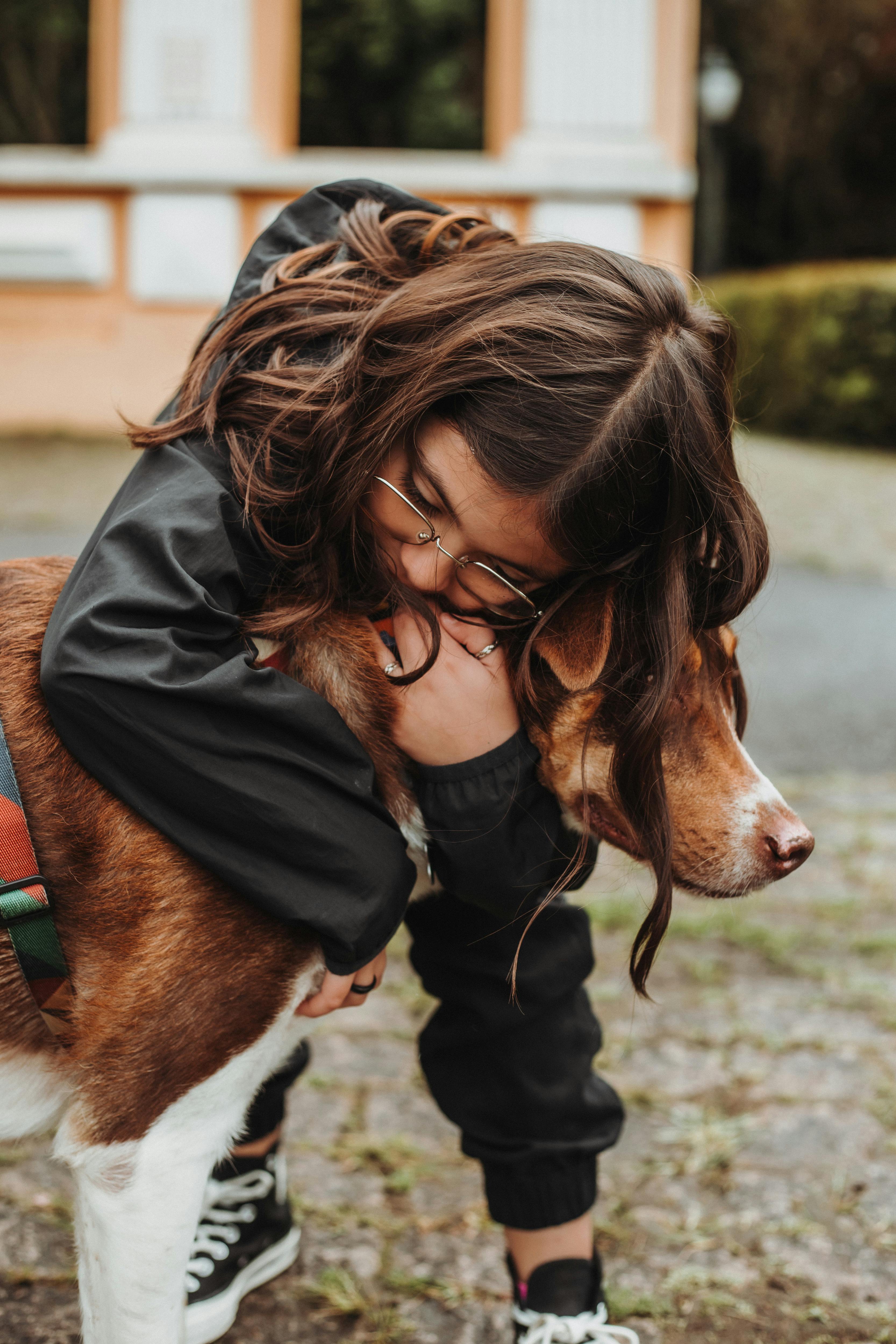 Girl in Cap Hugging Dog · Free Stock Photo
