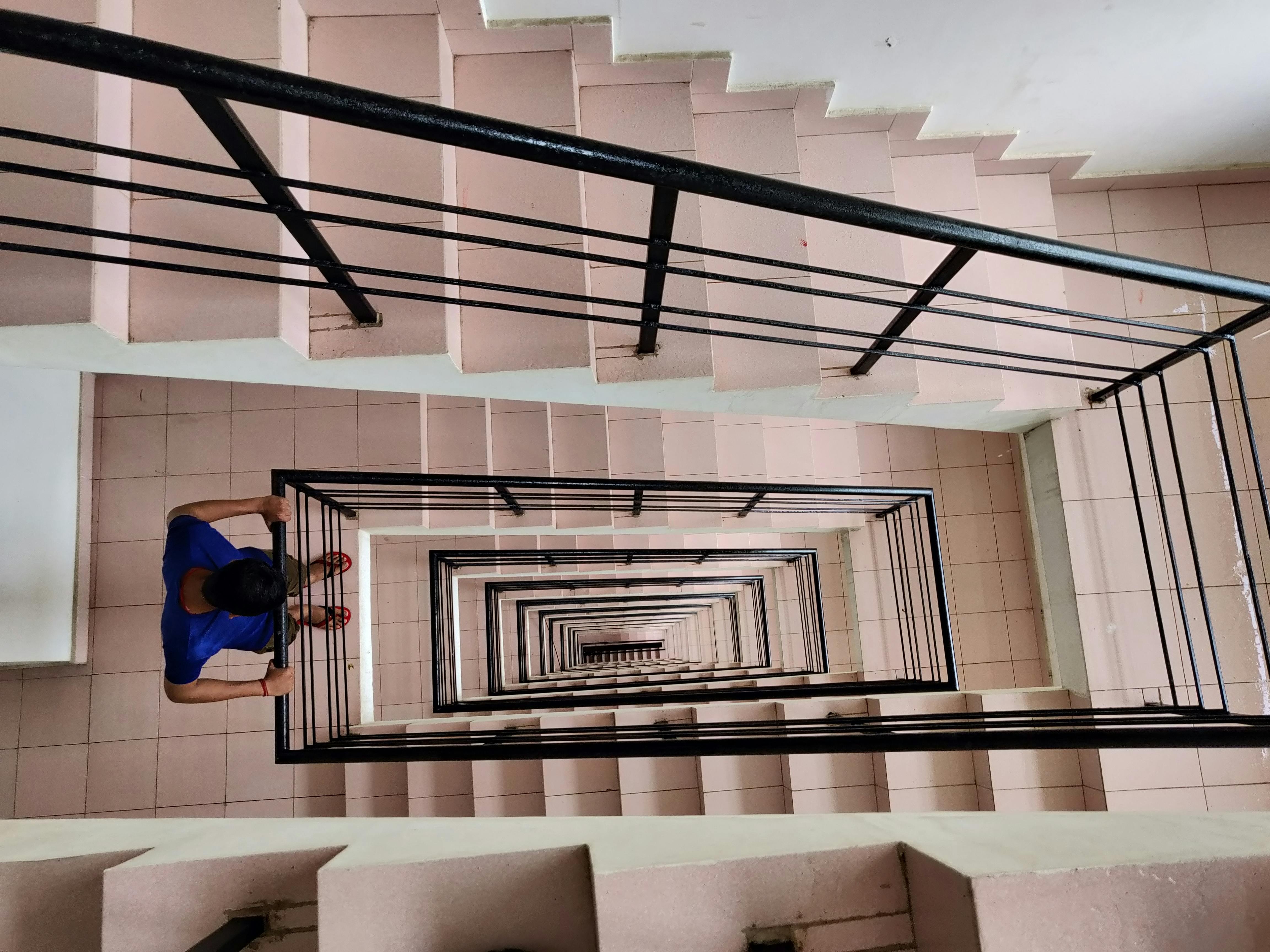 Man Looking Downwards of Stairs · Free Stock Photo