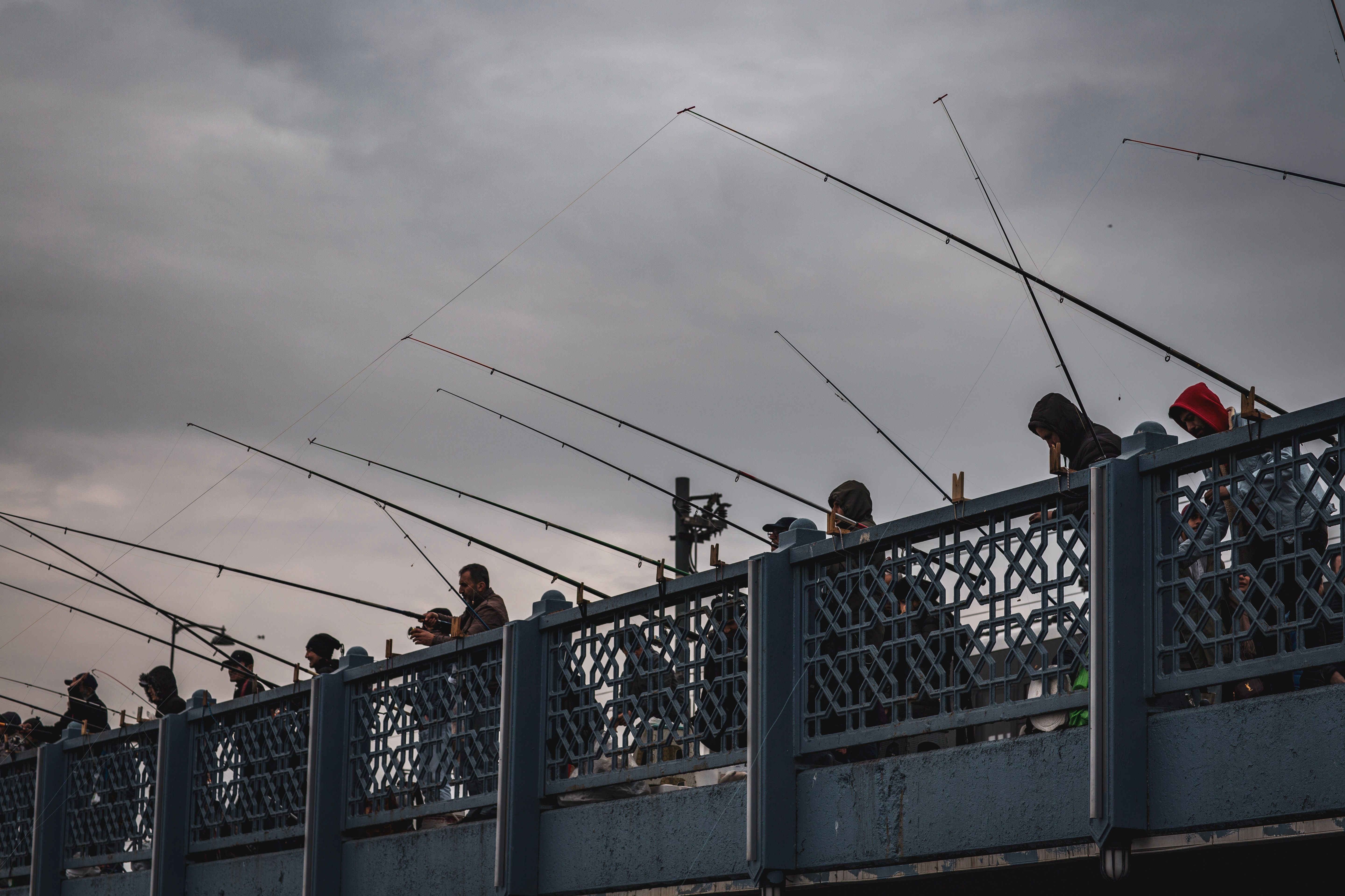 People Fishing on Bridge Under Cloudy Sky · Free Stock Photo