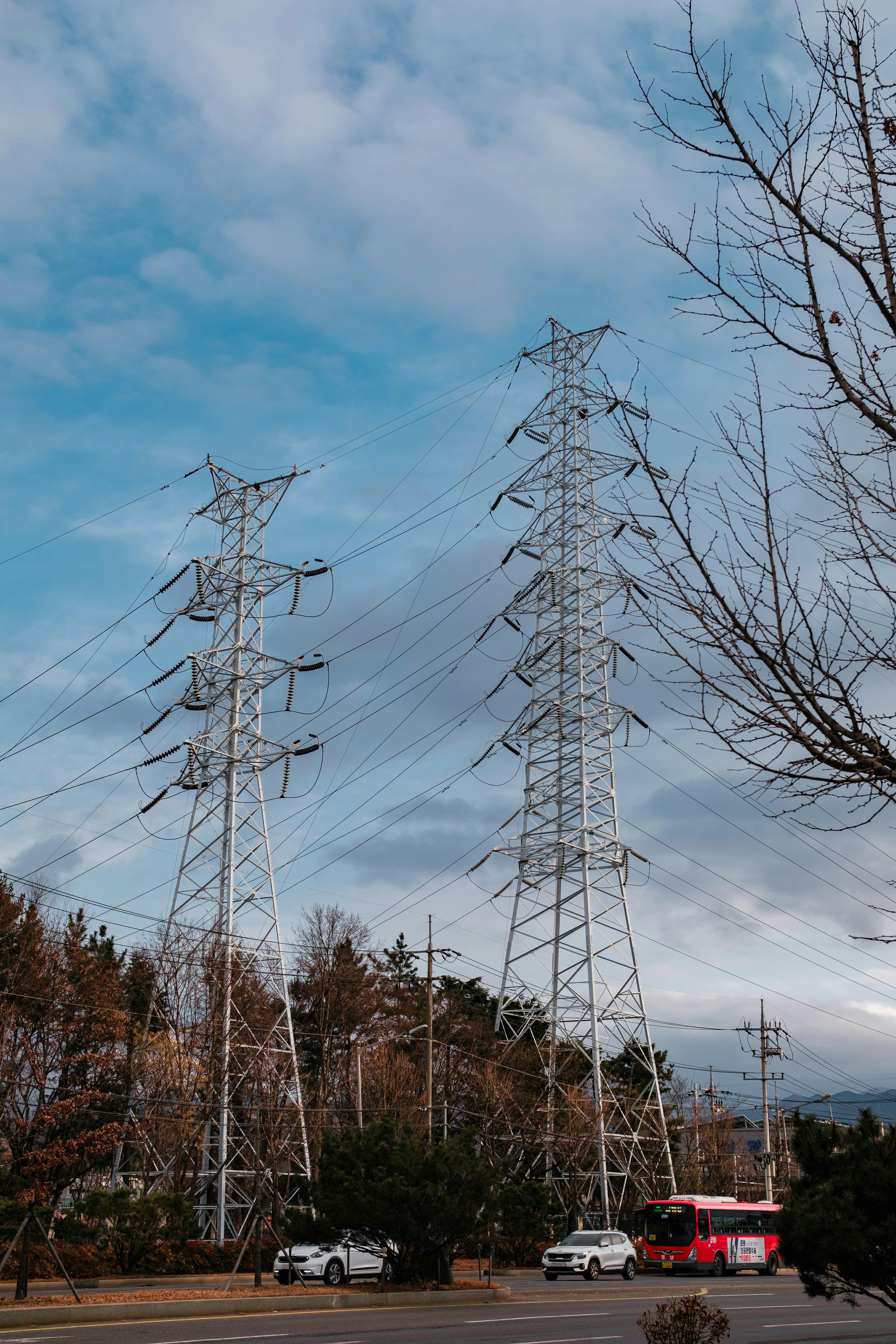 Electricity Pylons Along Street · Free Stock Photo