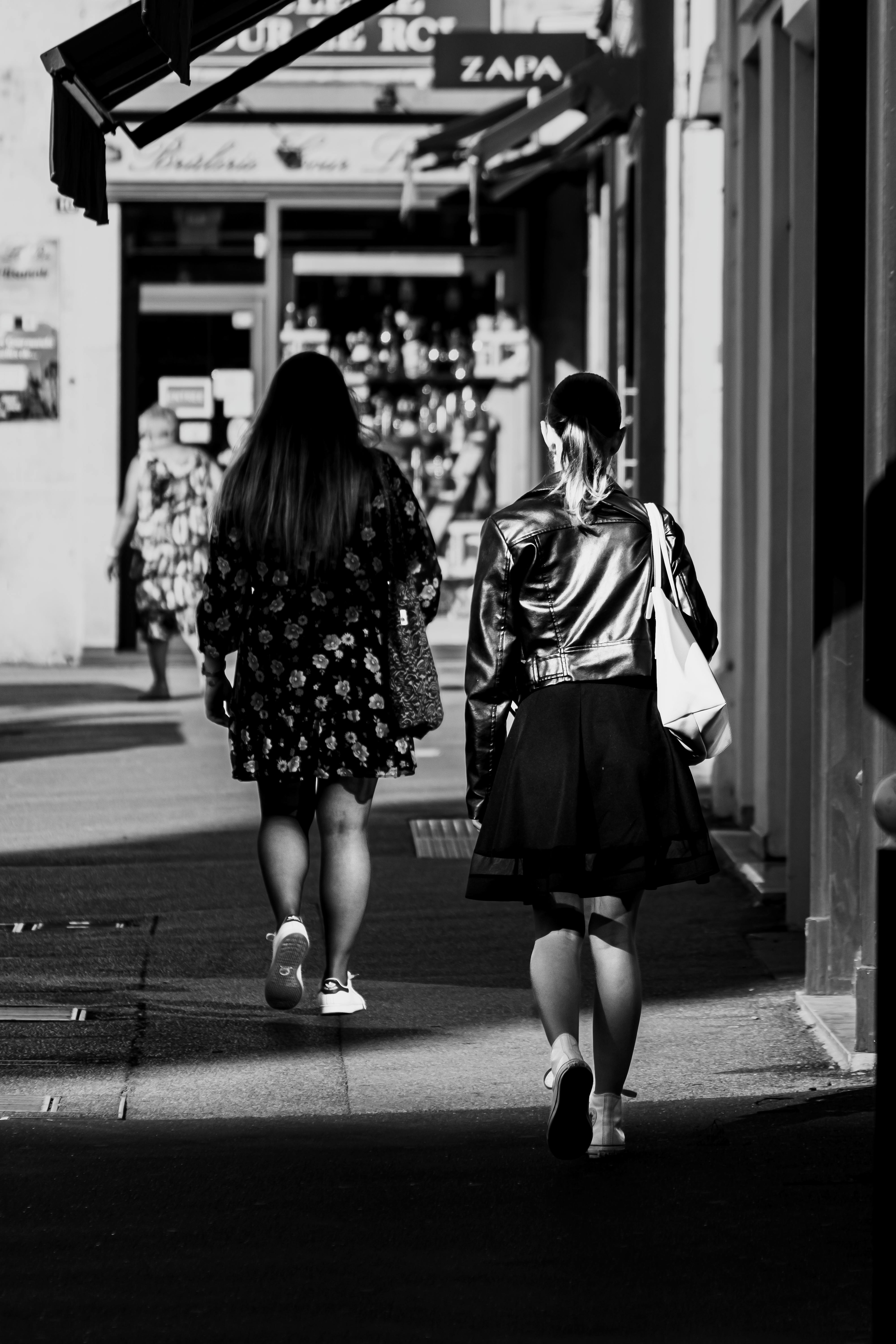 Woman Walking past a Glowing Sign · Free Stock Photo