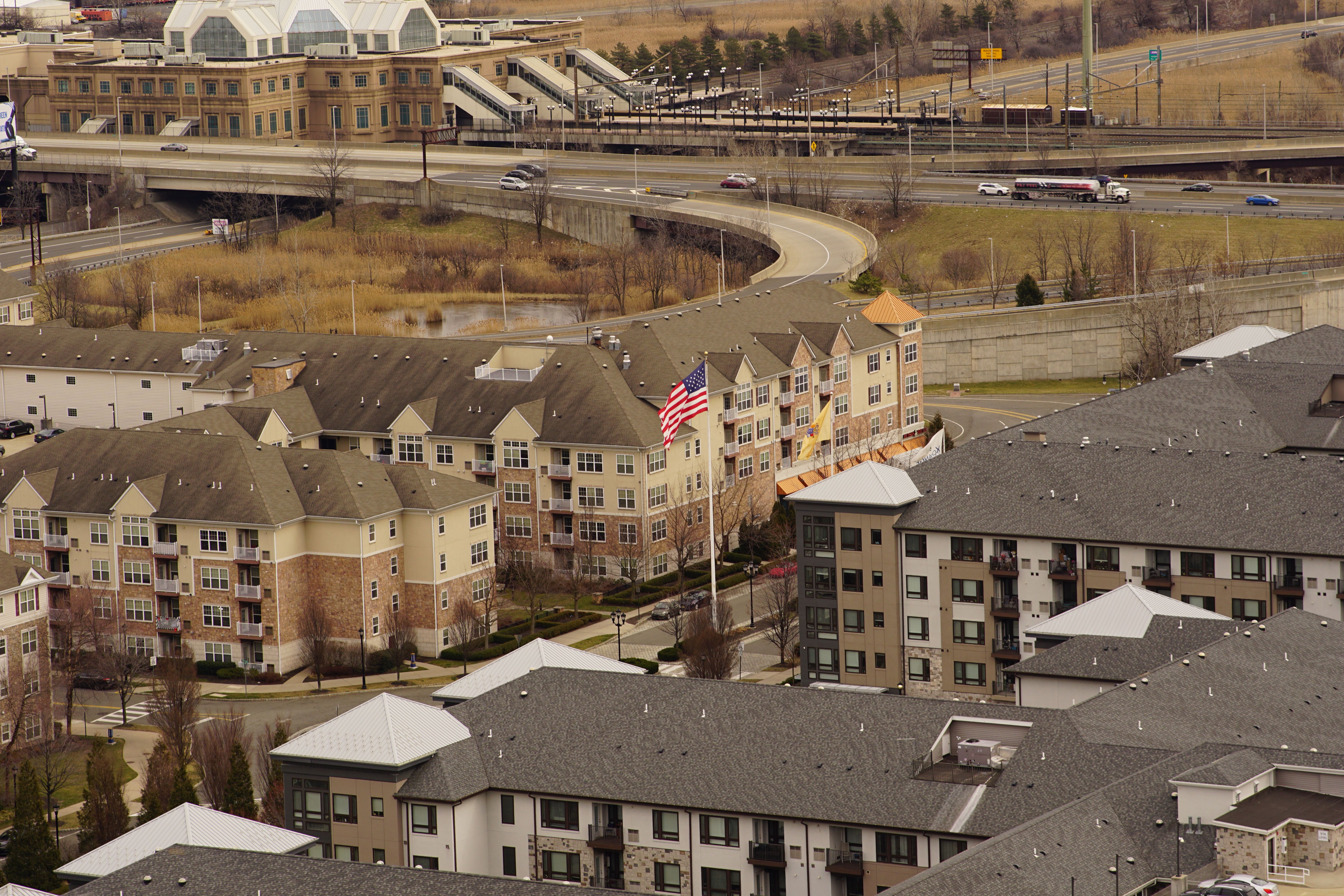 American Flag Among Apartment Buildings · Free Stock Photo