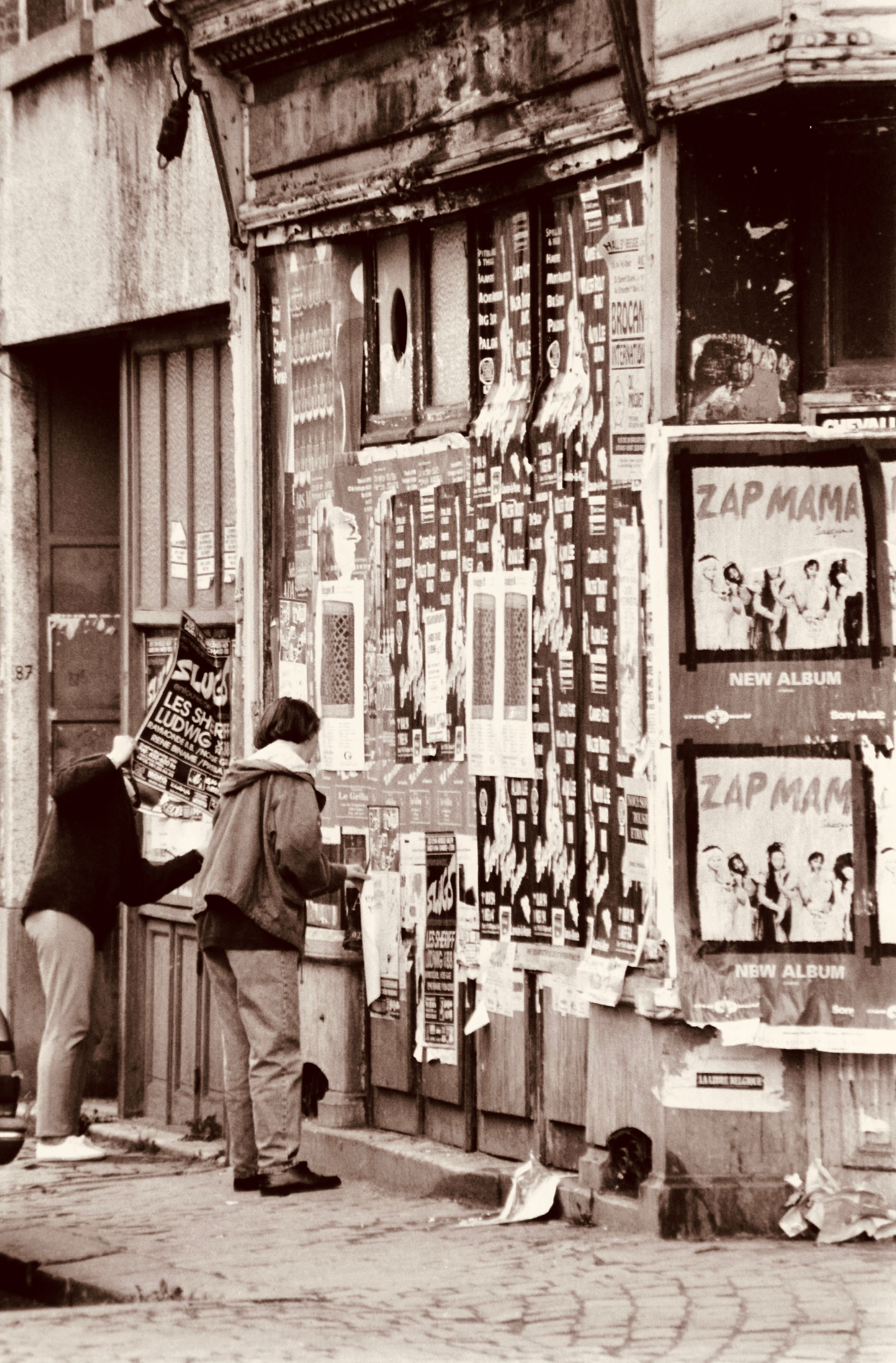 Store Facade with Posters in Windows and Door · Free Stock Photo