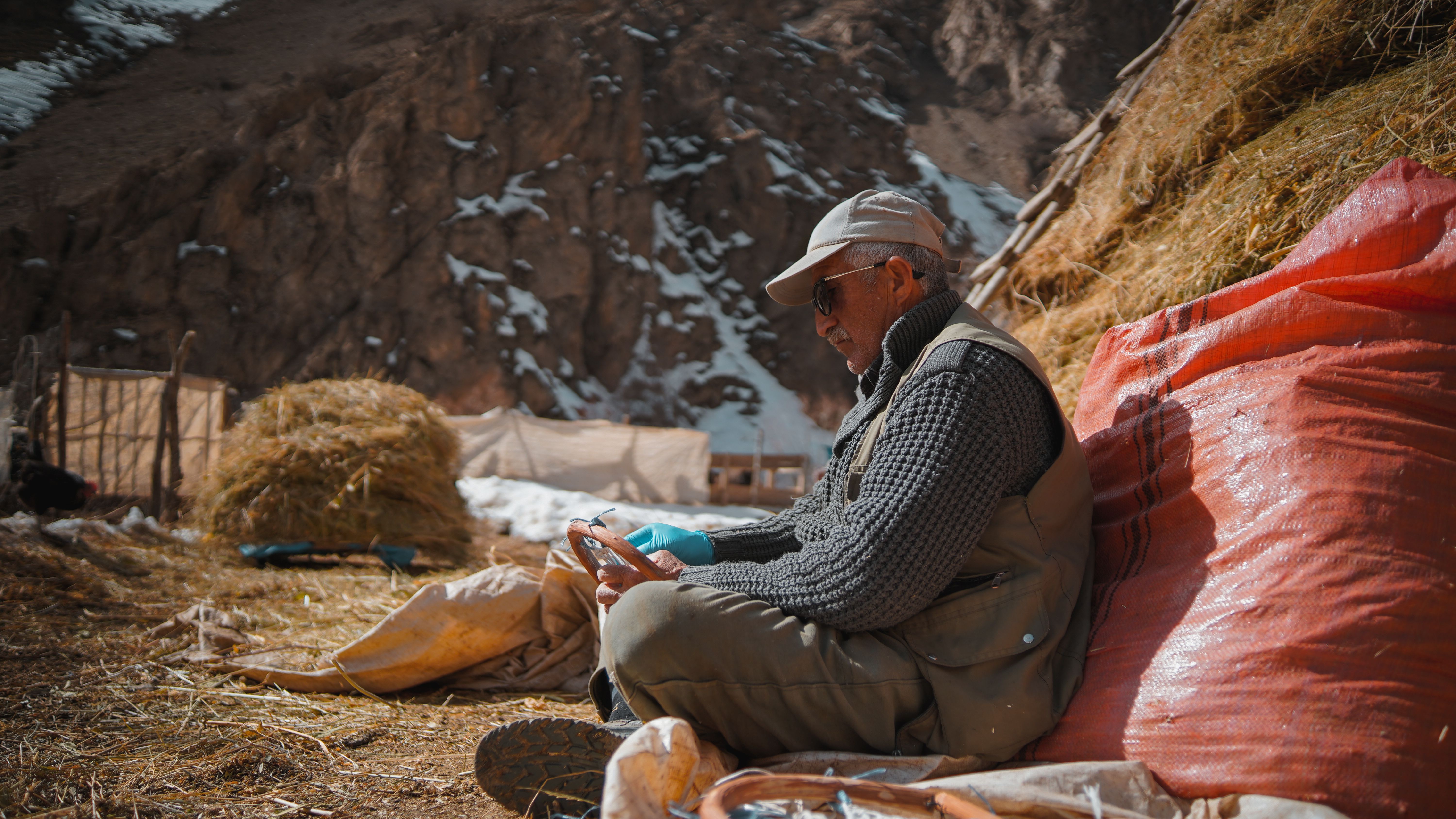 Man Sitting near House in Village · Free Stock Photo