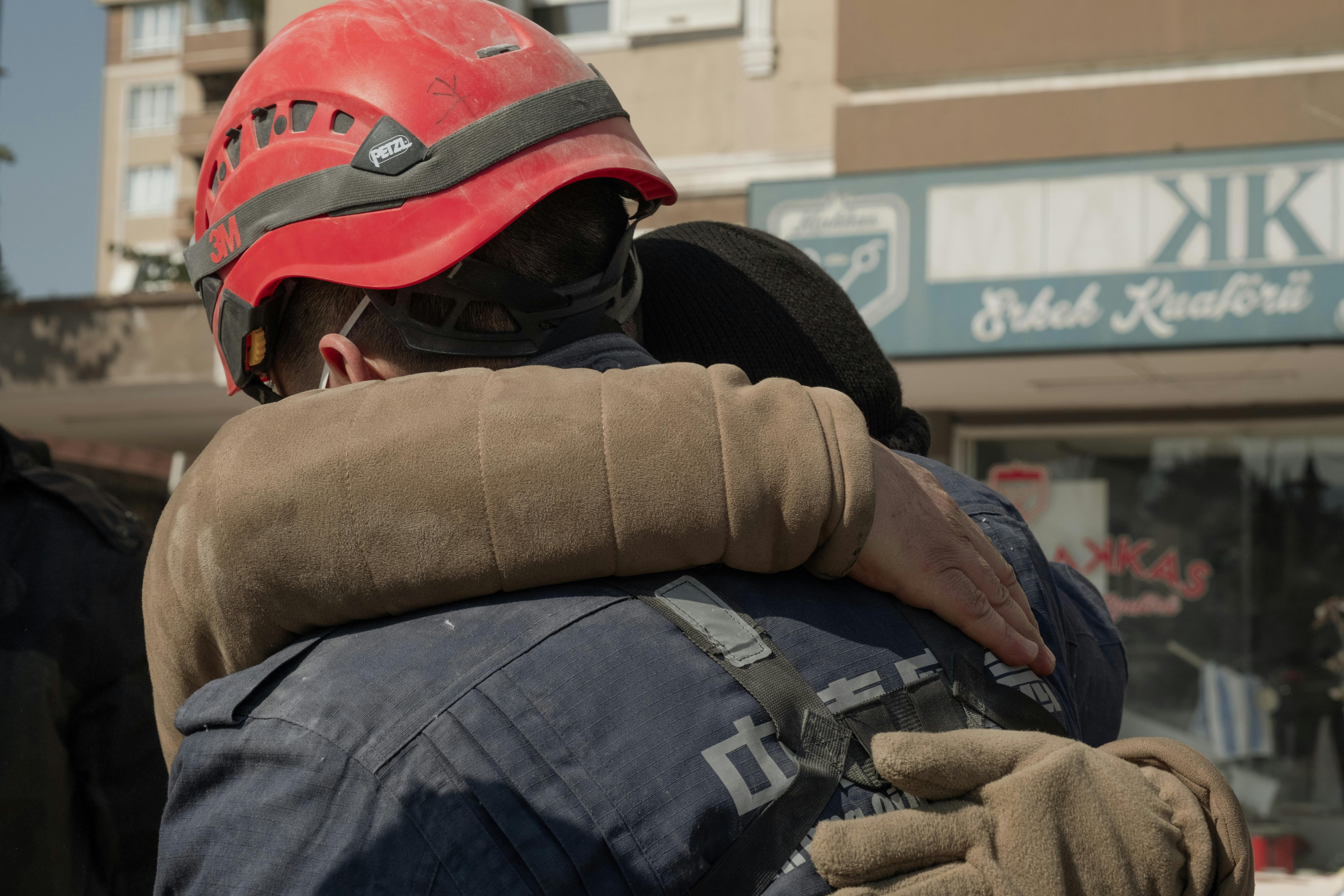 Person Embracing Rescuer After Earthquake · Free Stock Photo