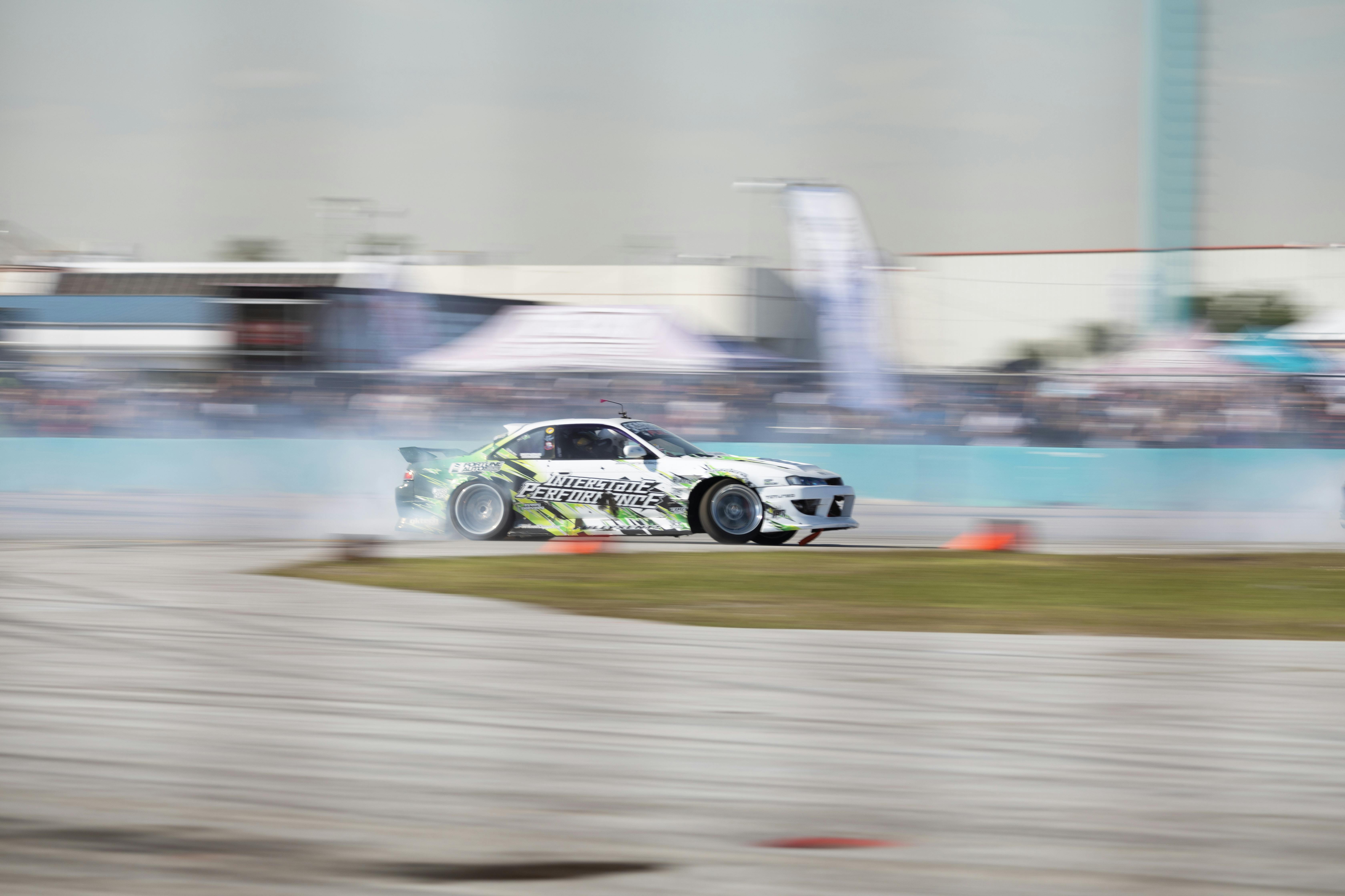 A car is drifting on a track · Free Stock Photo