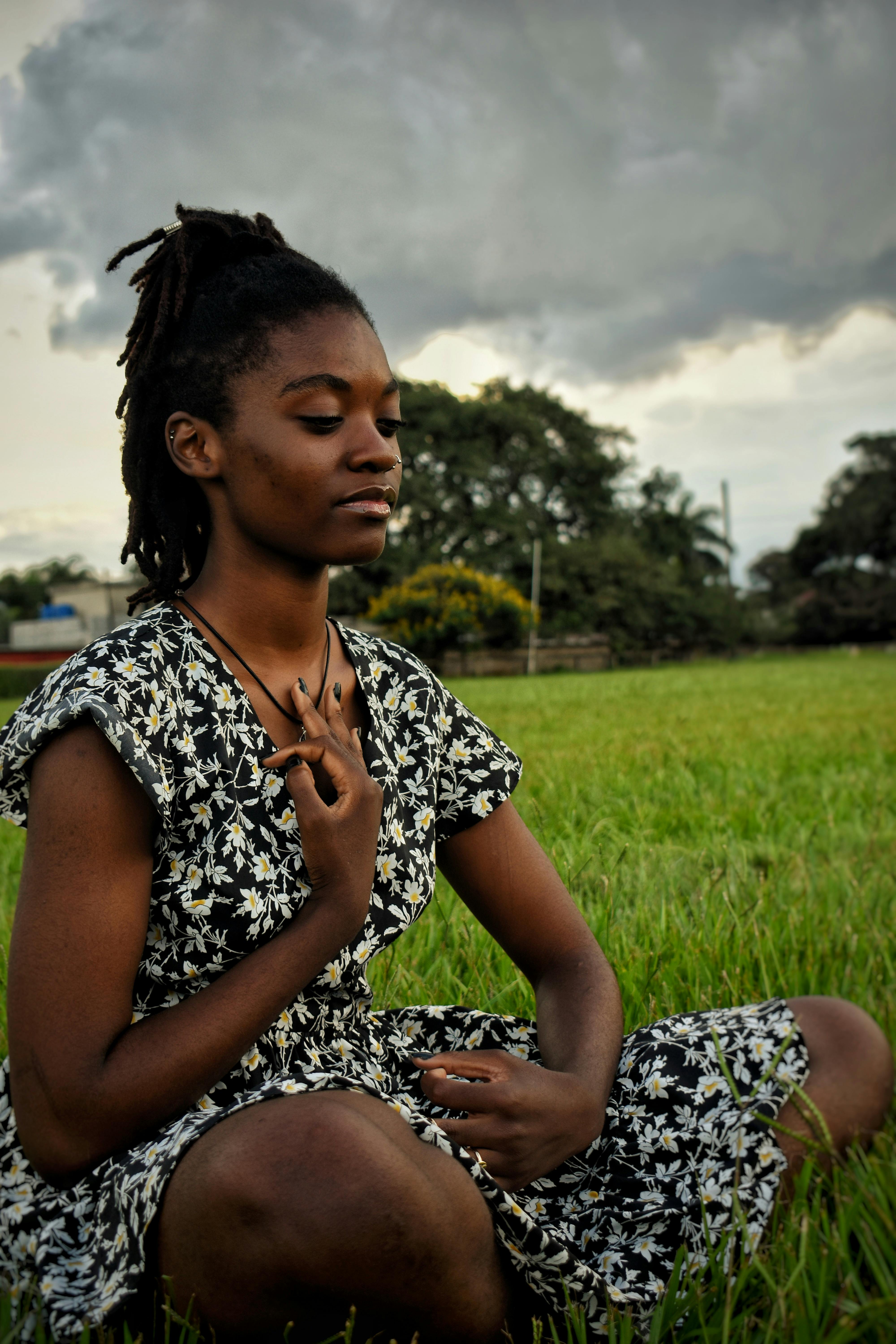 Woman Sitting on Grass Meditating · Free Stock Photo