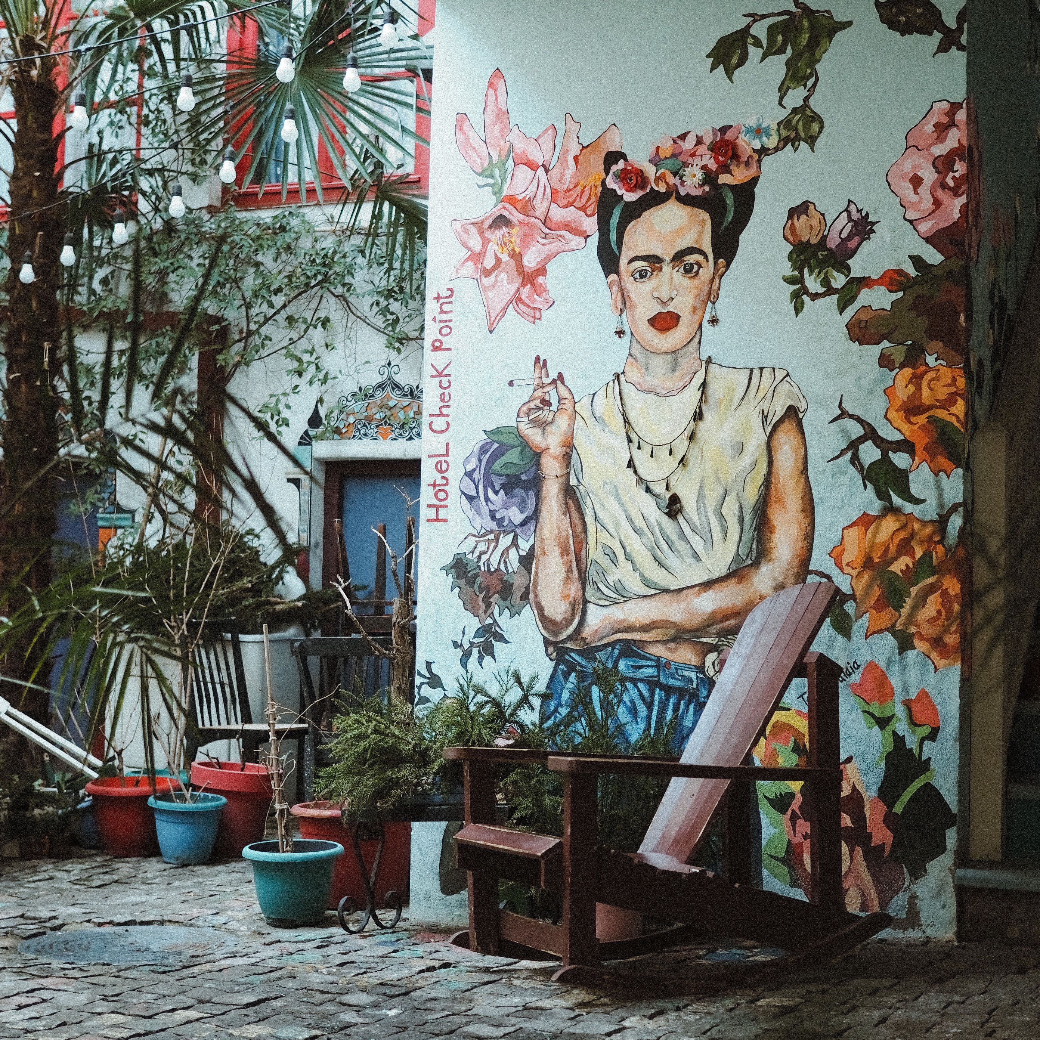 Graffiti on Building Wall in Yard with Plants · Free Stock Photo