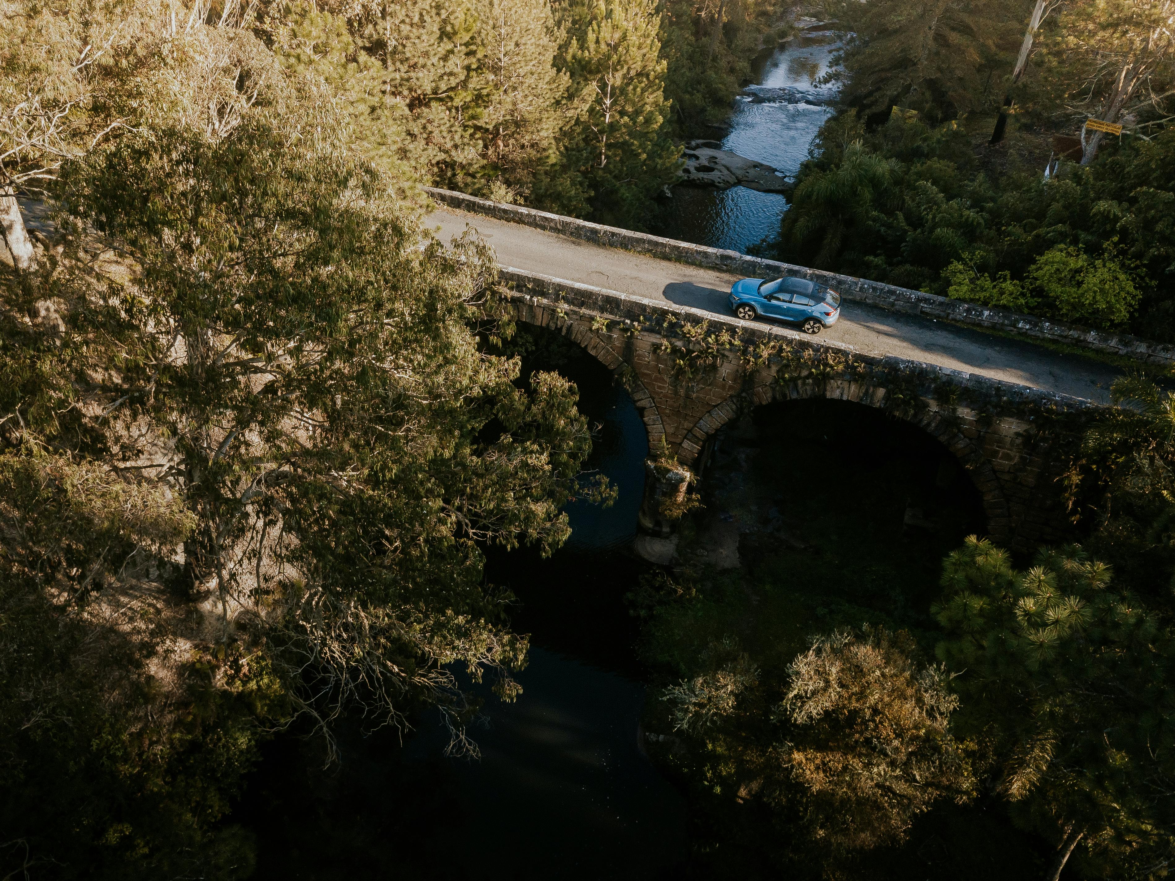Blue Car on Bridge over River · Free Stock Photo