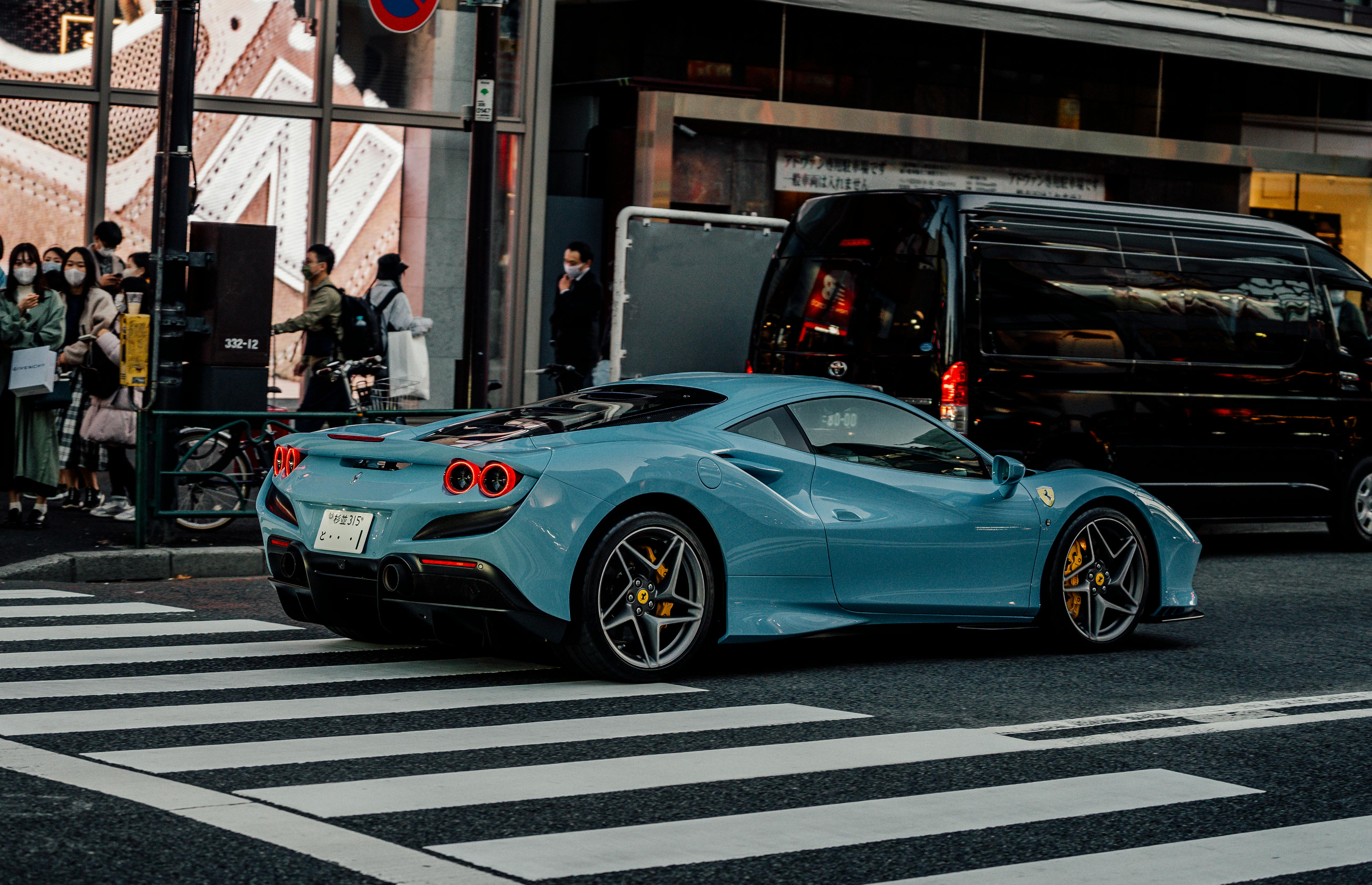 Photo of a Blue Sports Car by a Zebra Crossing · Free Stock Photo